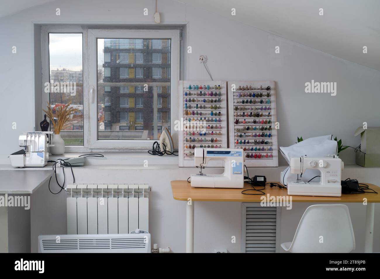 Interior of a modern tailor shop with sewing machine and accessories ...