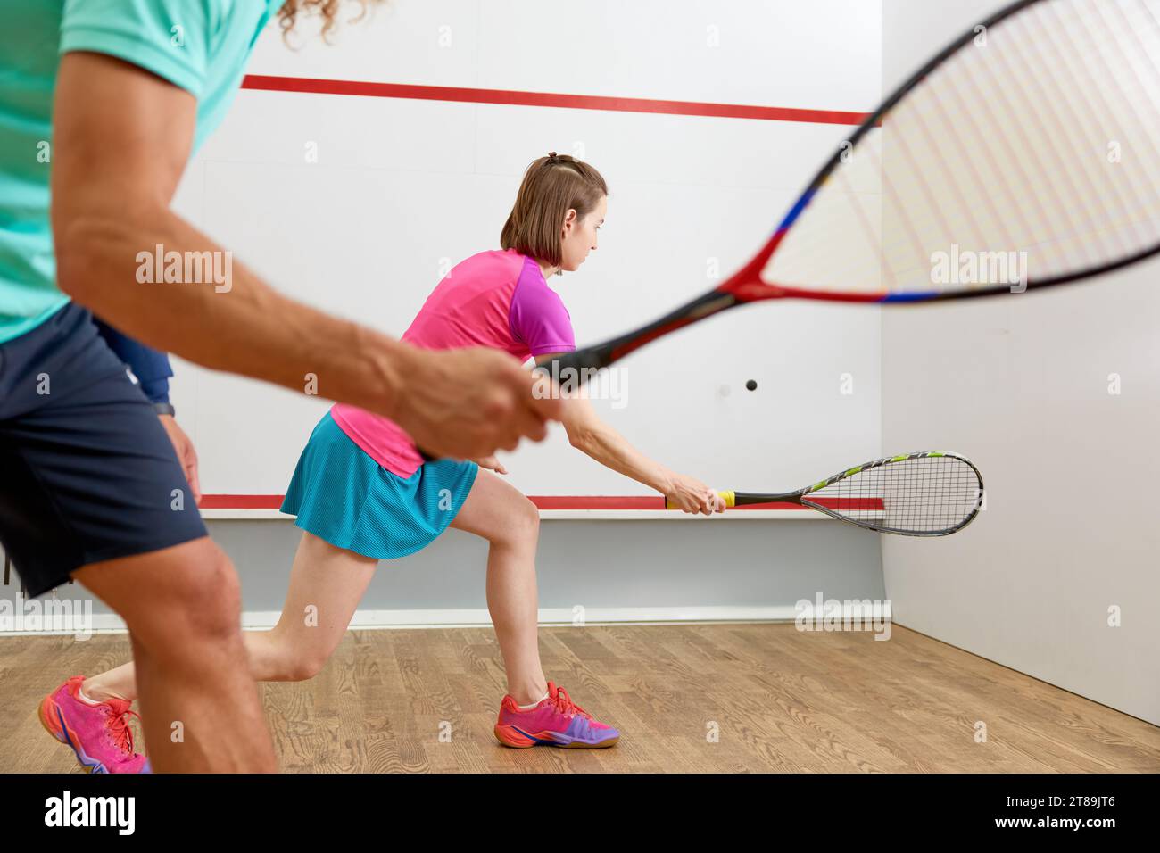 People playing squash enjoying recreational pursuit at indoor training ...