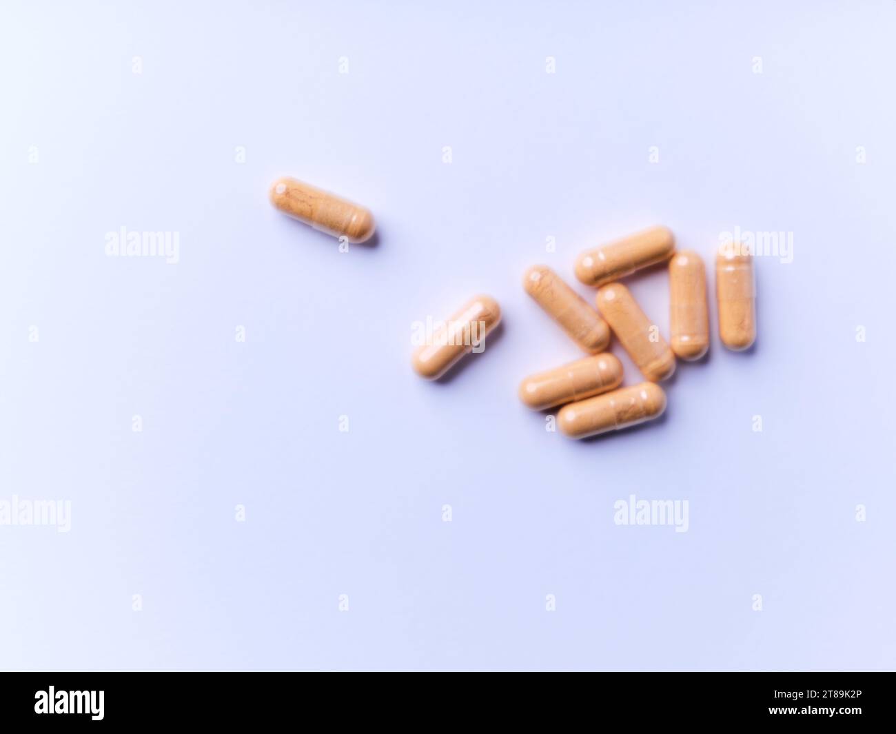 Lutein capsules. Dietary supplement on bright paper background. Soft ...