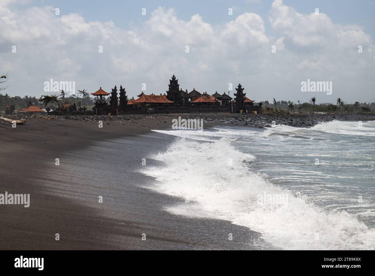 Black sand beach in Bali, natural with temples, boats (jukung) and ...
