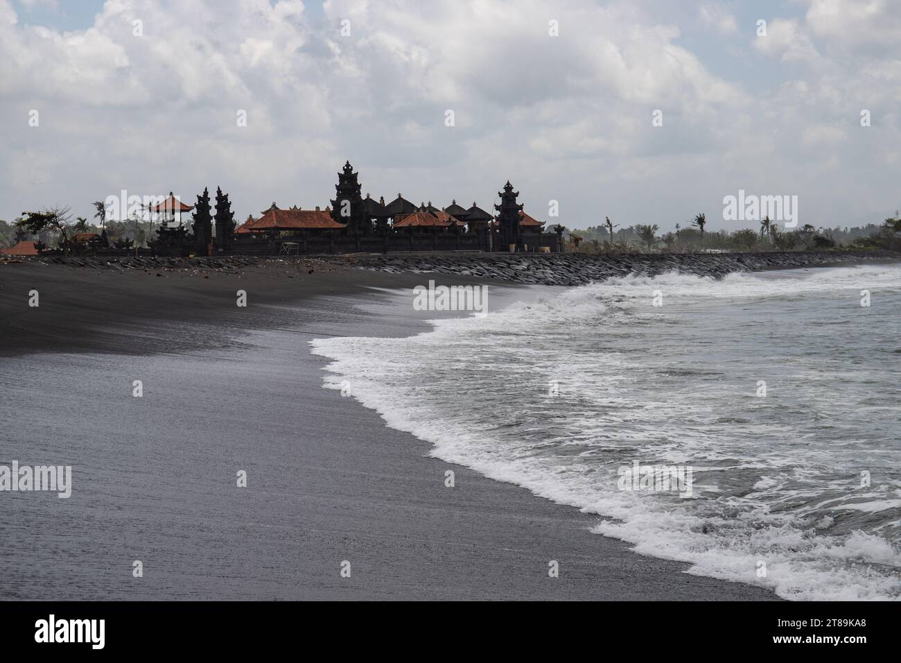 Black sand beach in Bali, natural with temples, boats (jukung) and ...
