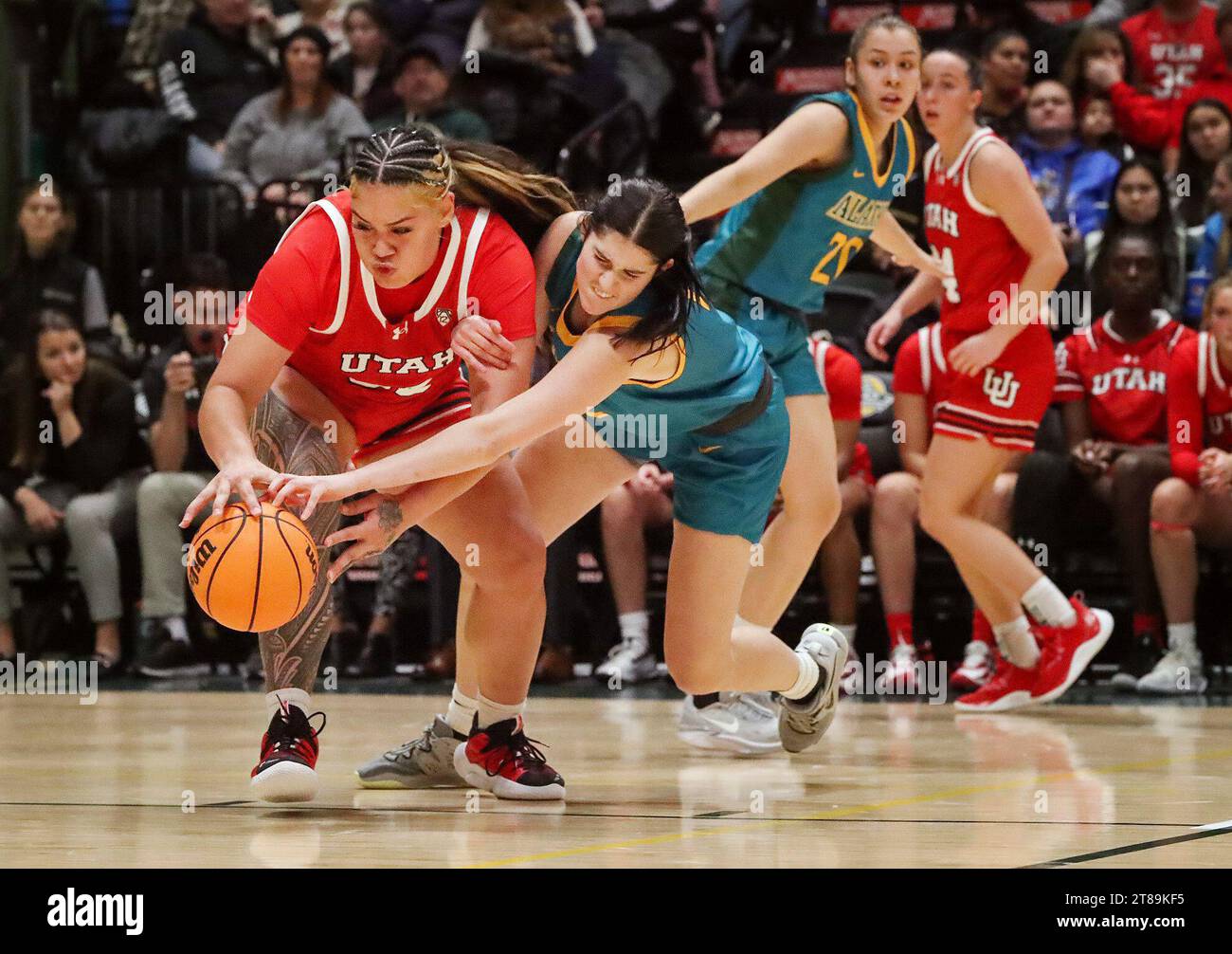 Utah's Alissa Pili, left, fights to keep control of the ball as UAA's ...