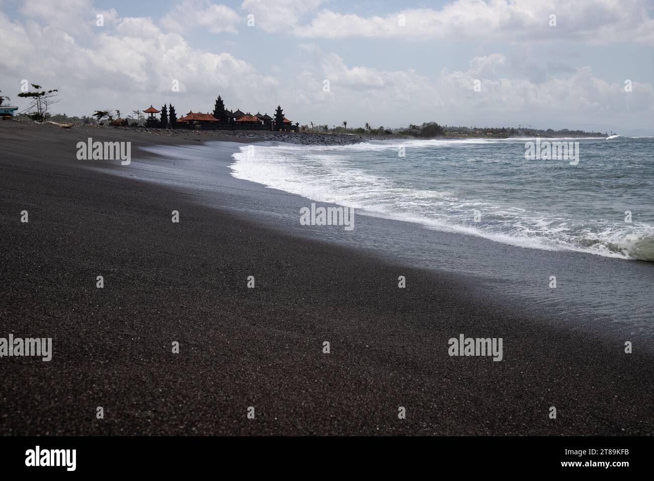 Black sand beach in Bali, natural with temples, boats (jukung) and ...