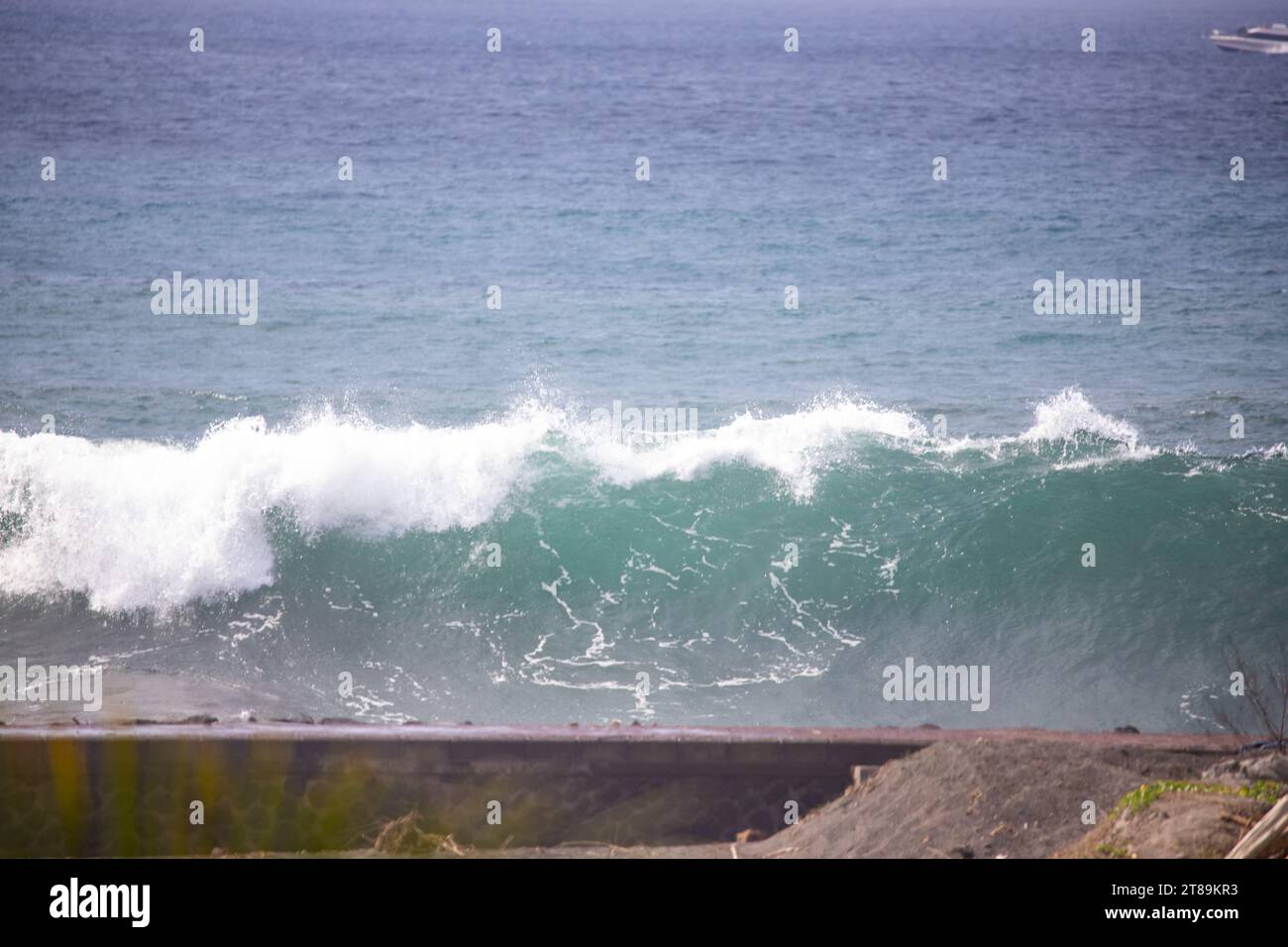 Black sand beach in Bali, with white waves and spray. lava sand beach ...