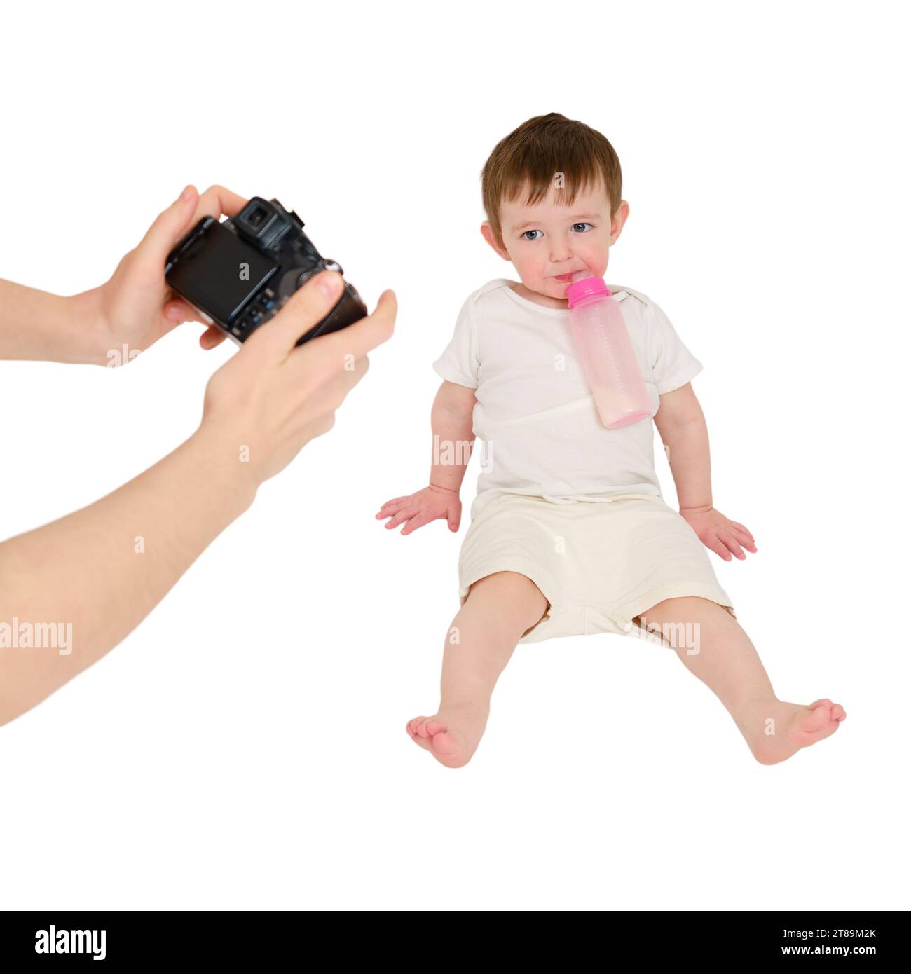Woman mother photographs baby on photo camera, studio, isolated on ...