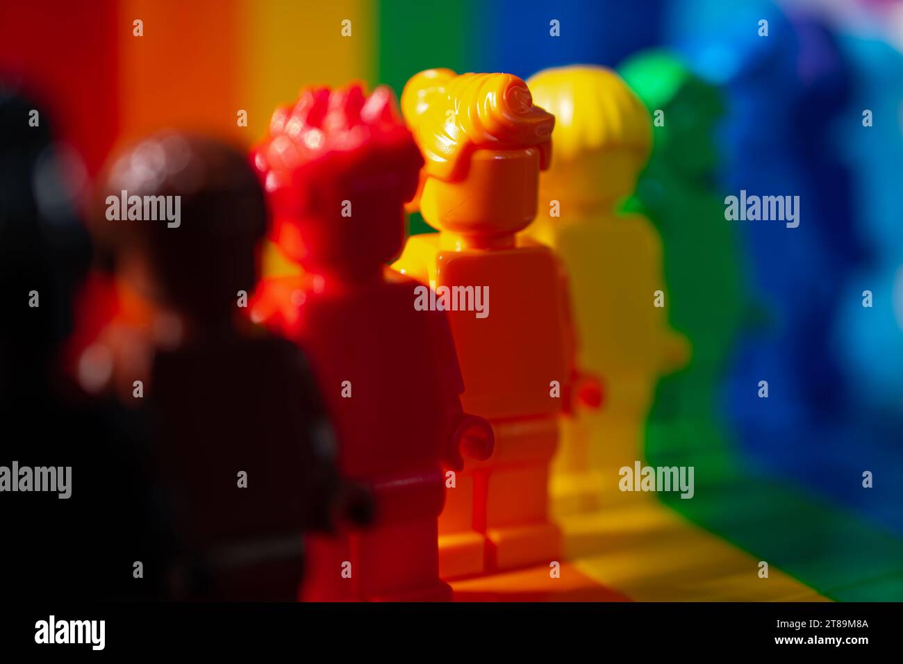 A colourful array of LEGO pieces arranged on a bright white background ...