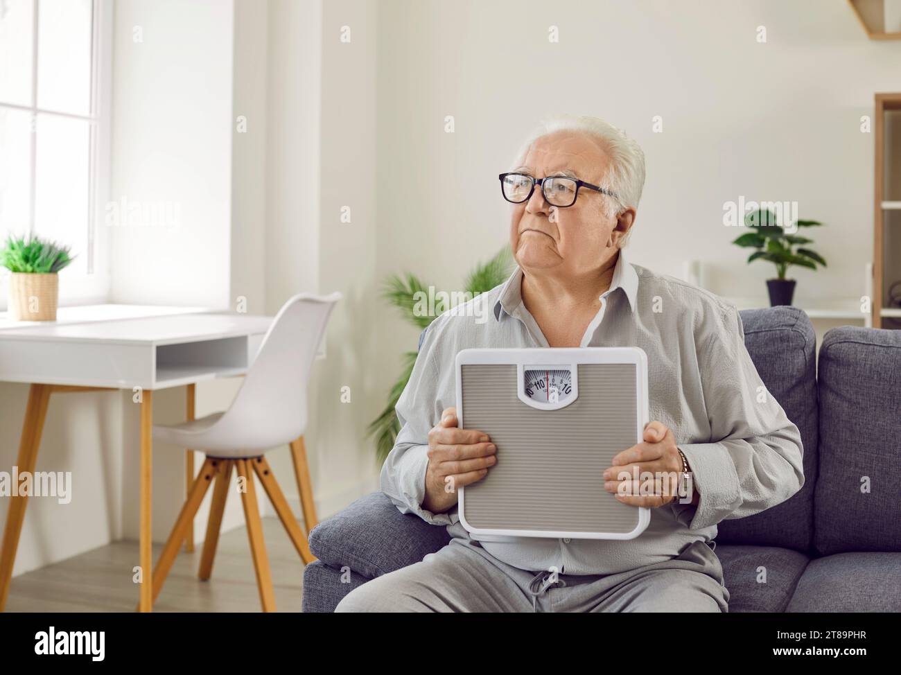 Senior man with scales is worrying about his health and thinking about ...