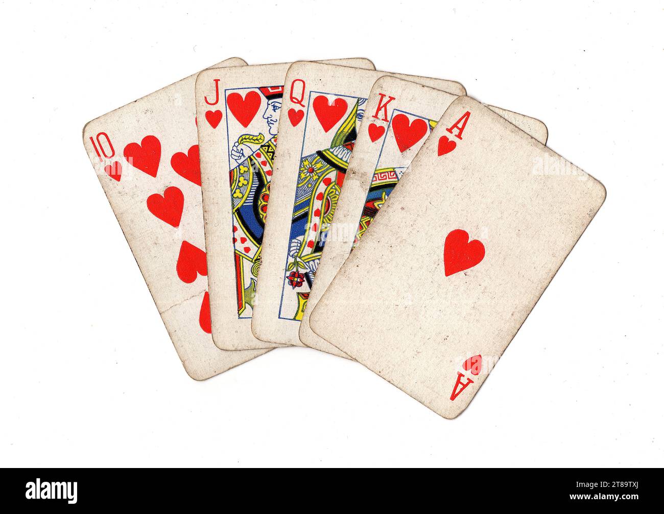 A poker hand of vintage playing cards showing a royal flush of hearts ...