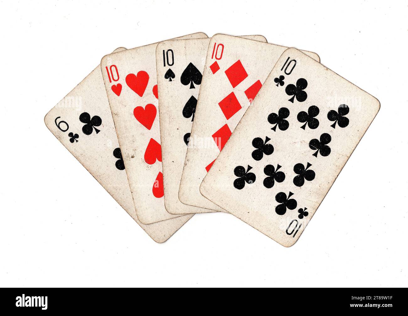 A poker hand of vintage playing cards showing a four tens on a white ...