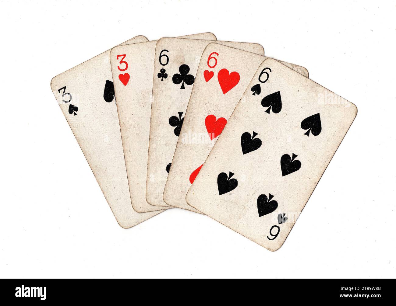 A poker hand of vintage playing cards showing a full house of sixes and ...