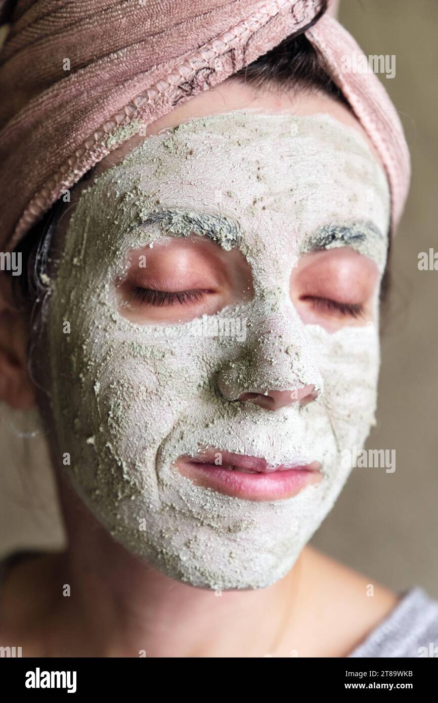 The woman applied green clay to her face as part of her regular ...