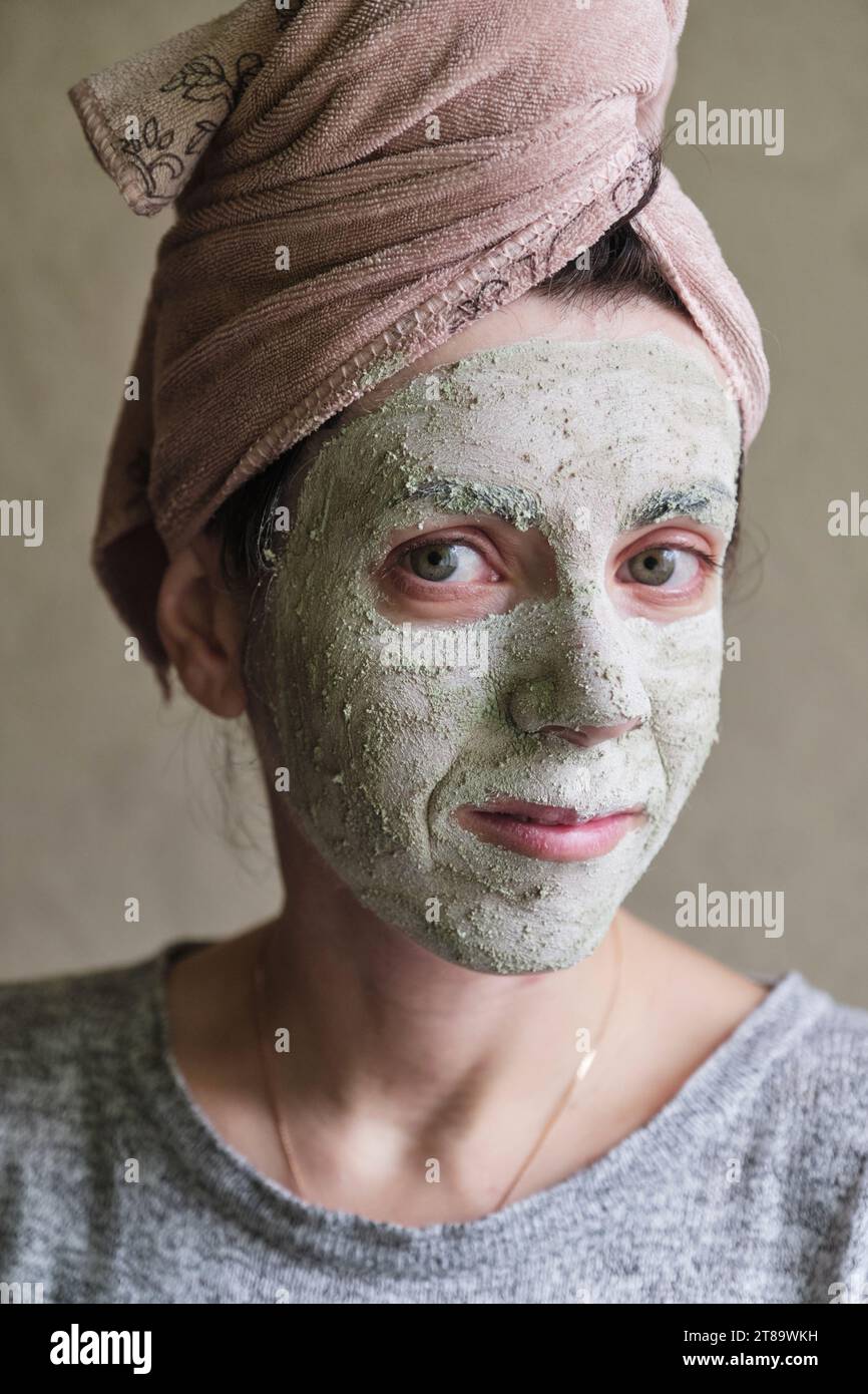 The woman applied green clay to her face as part of her regular ...