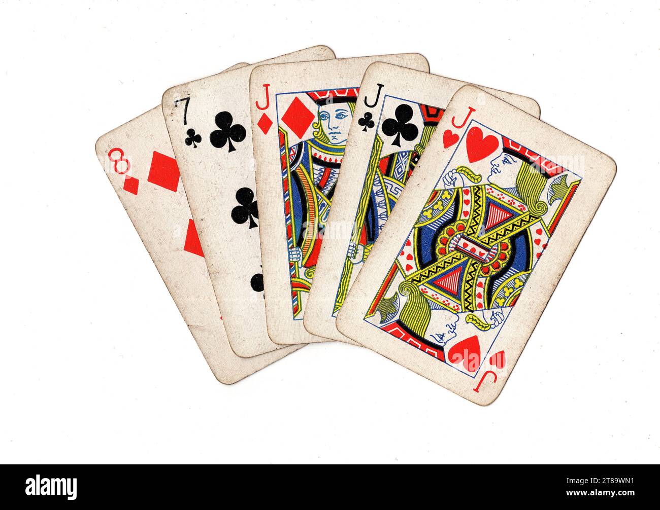 A poker hand of vintage playing cards showing three jacks on a white ...