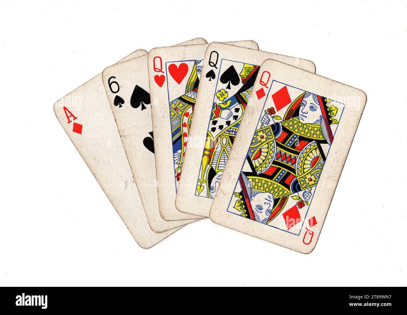 A poker hand of vintage playing cards showing three queens on a white ...
