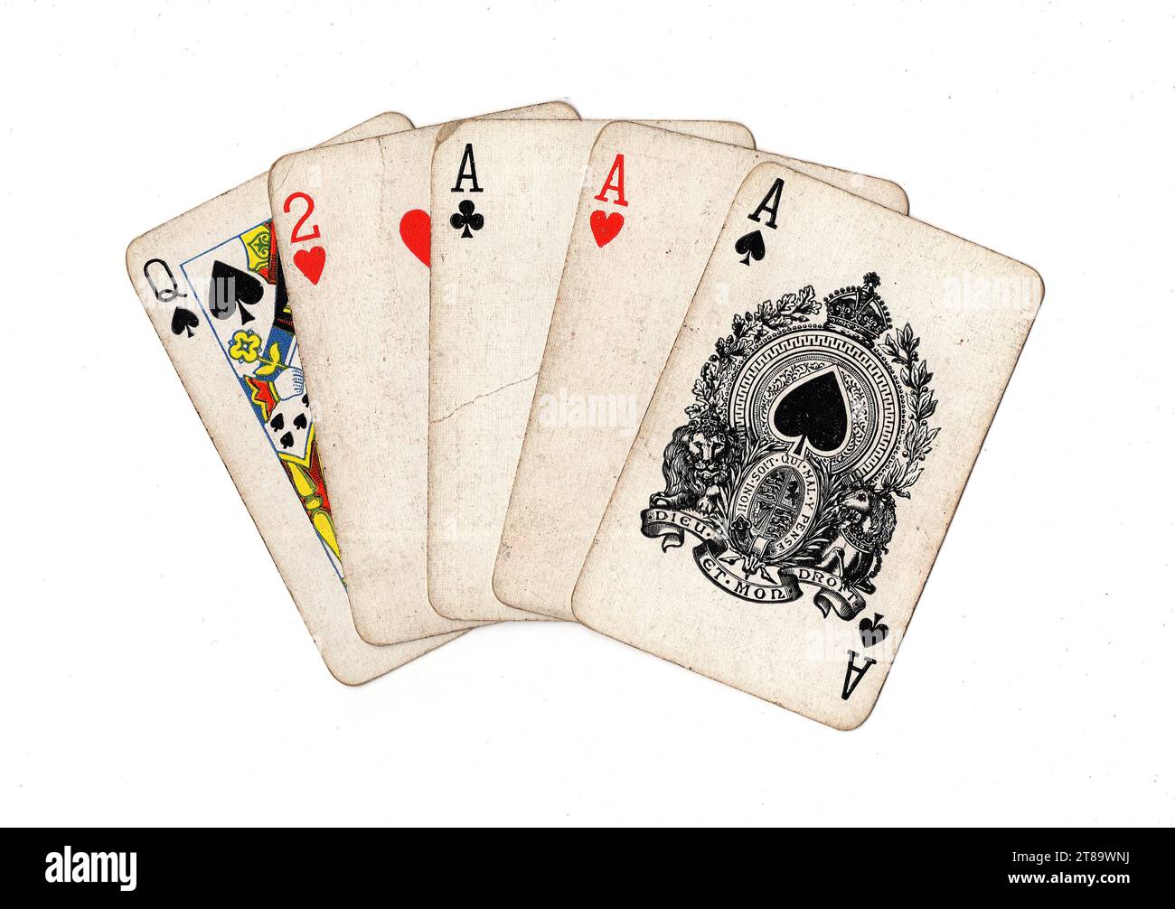A poker hand of vintage playing cards showing three aces on a white ...