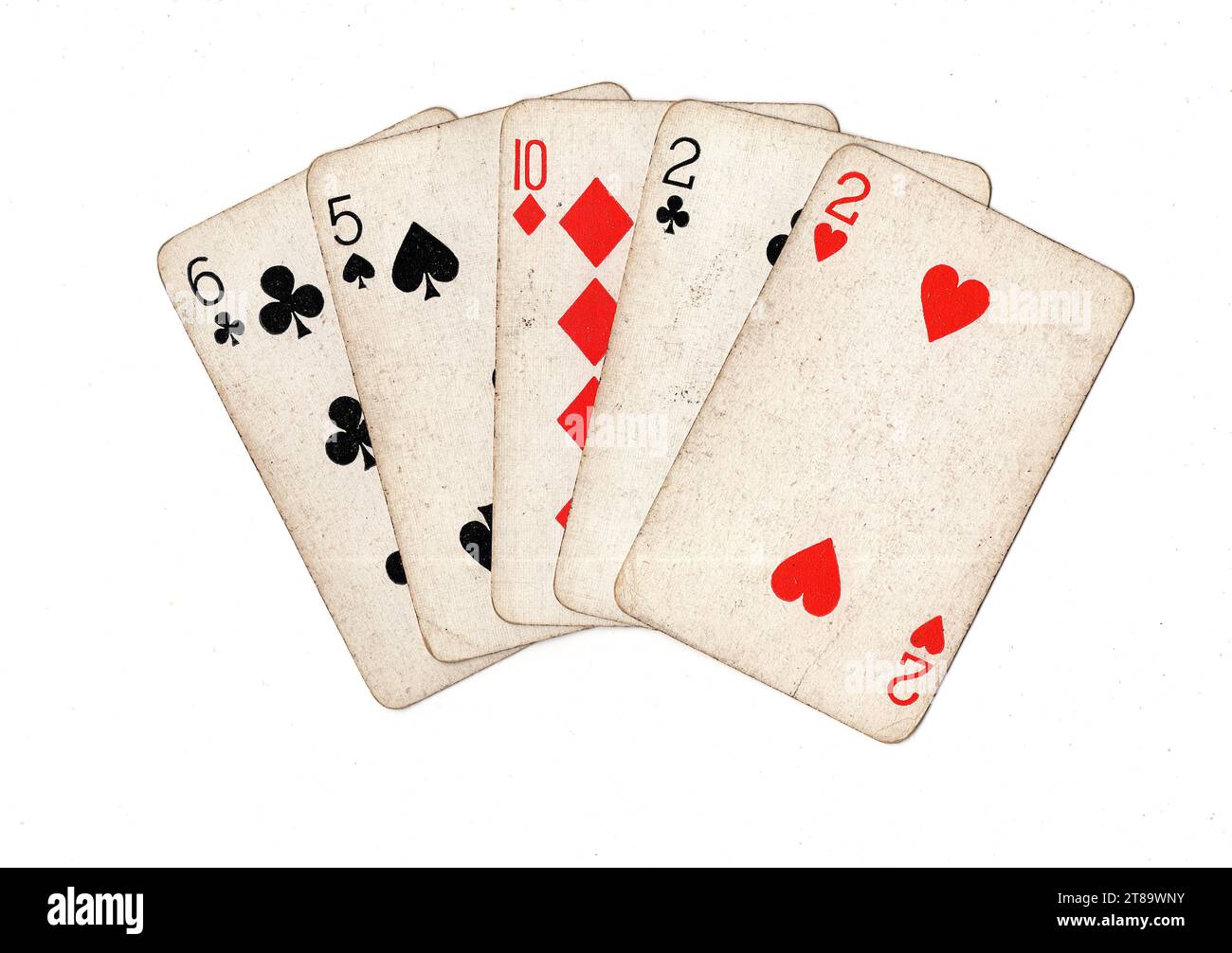 A poker hand of vintage playing cards showing a pair of twos on a white ...