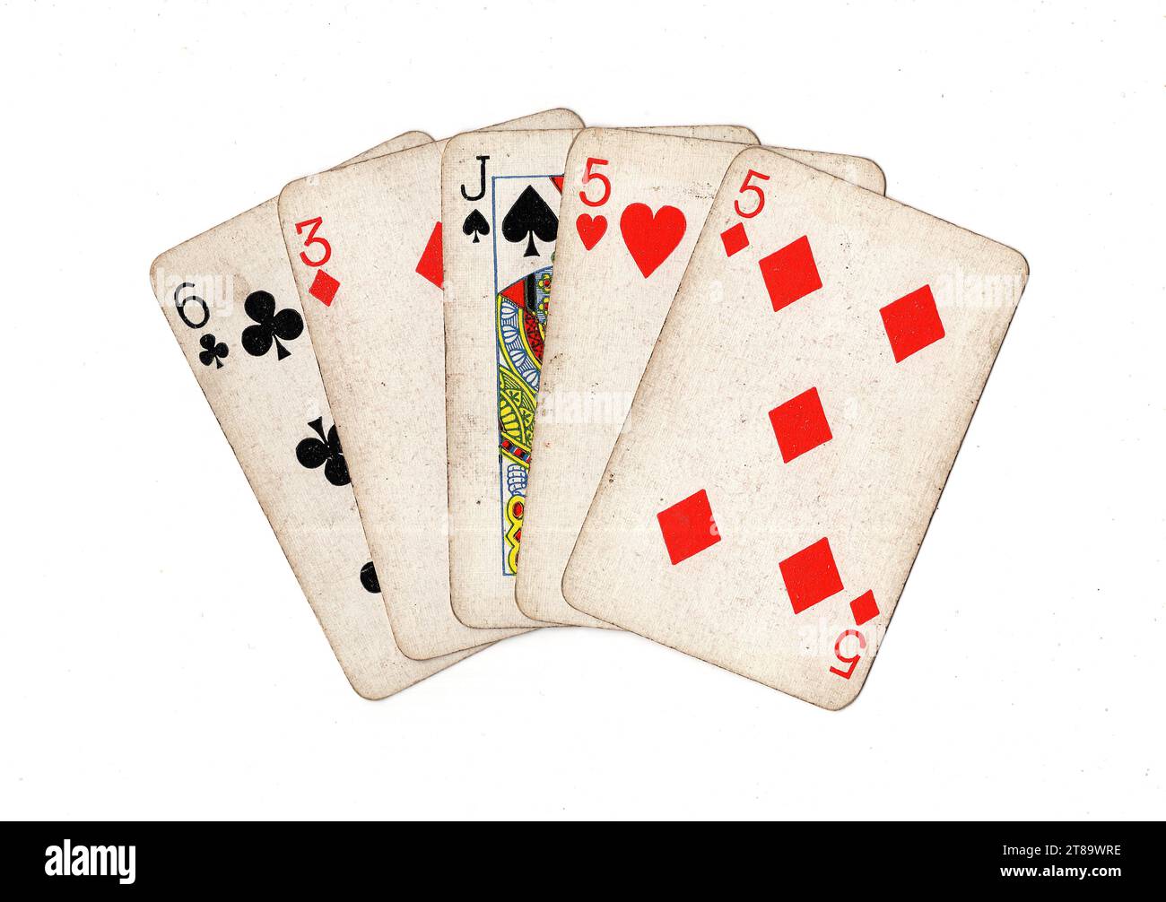 A poker hand of vintage playing cards showing a pair of fives on a ...