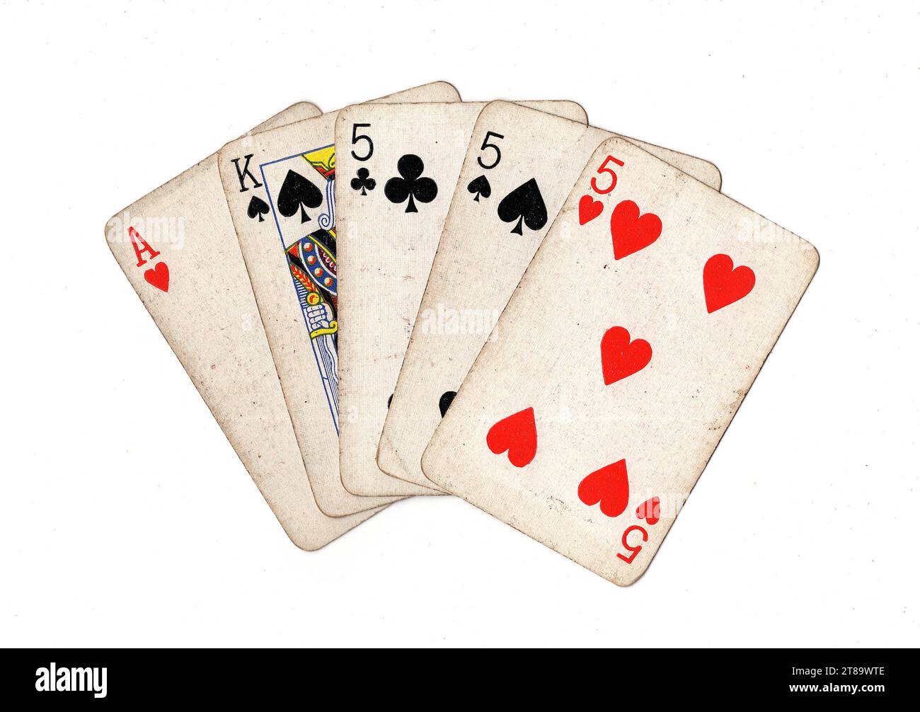 A poker hand of vintage playing cards showing three fives on a white ...
