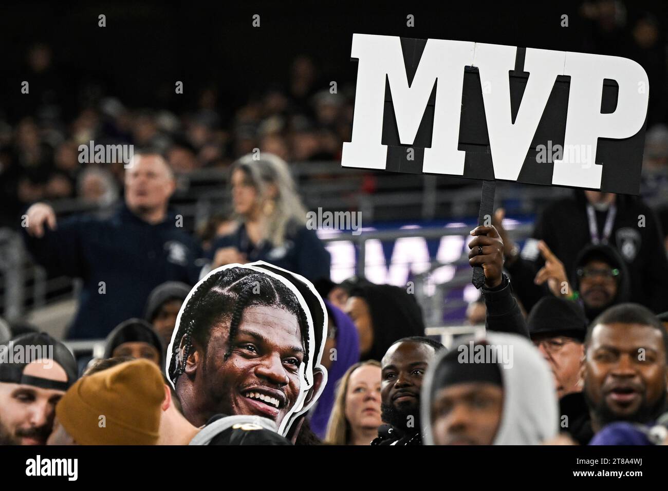 Fans hold a picture of Baltimore Ravens quarterback Lamar Jackson and ...