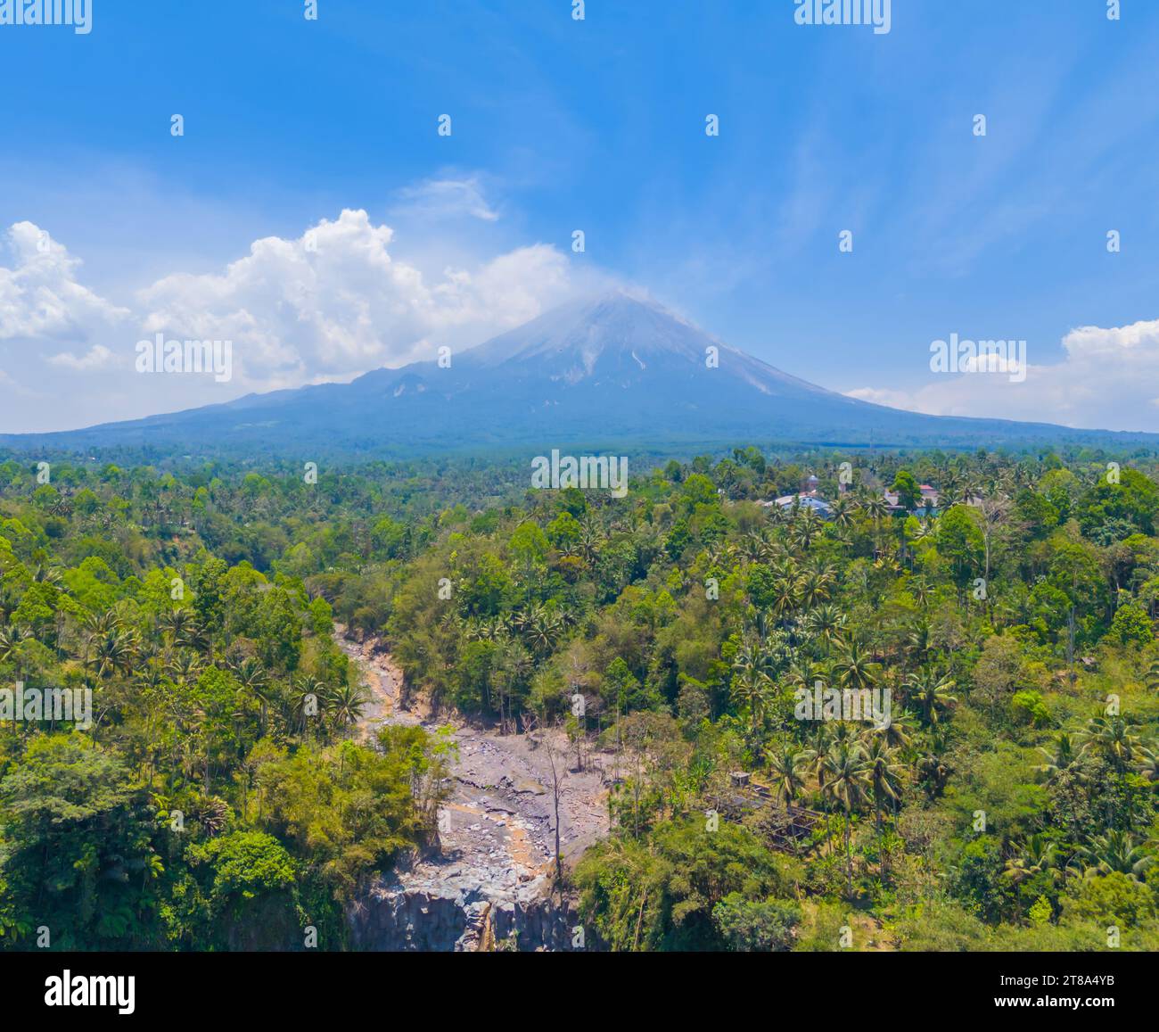 Aerial view of the Tumpak Sewu waterfall and Semeru volcano and jungle ...