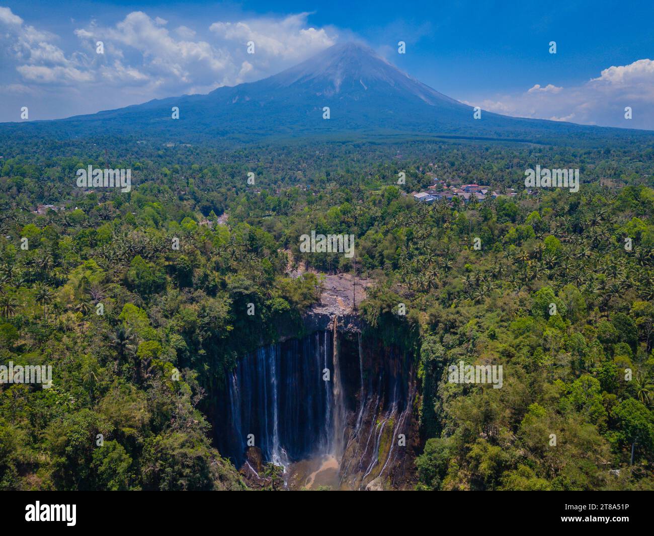 Aerial view of the Tumpak Sewu waterfall and Semeru volcano and jungle ...