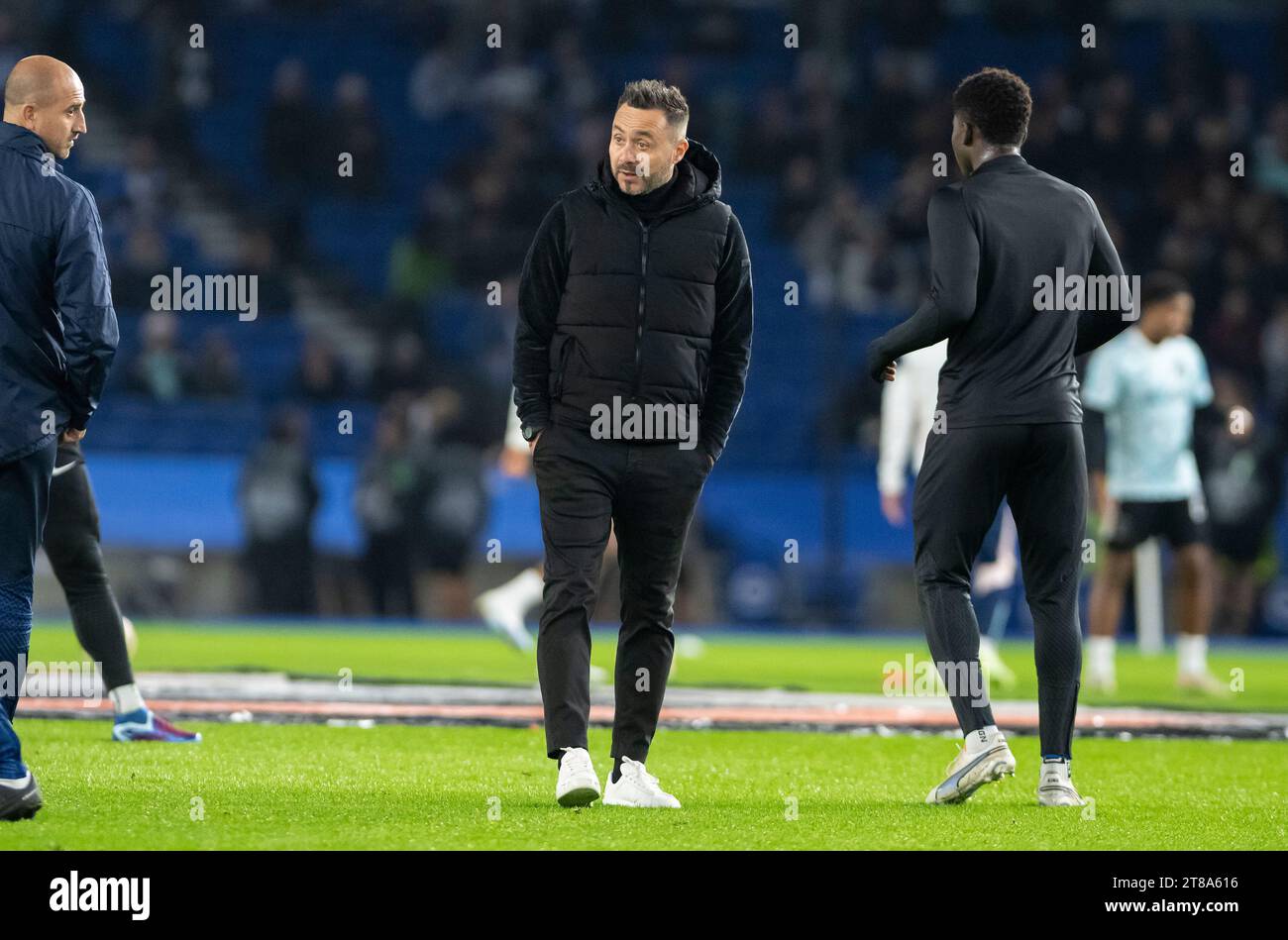 Brighton head coach Roberto De Zerbi watches his team warm up before ...