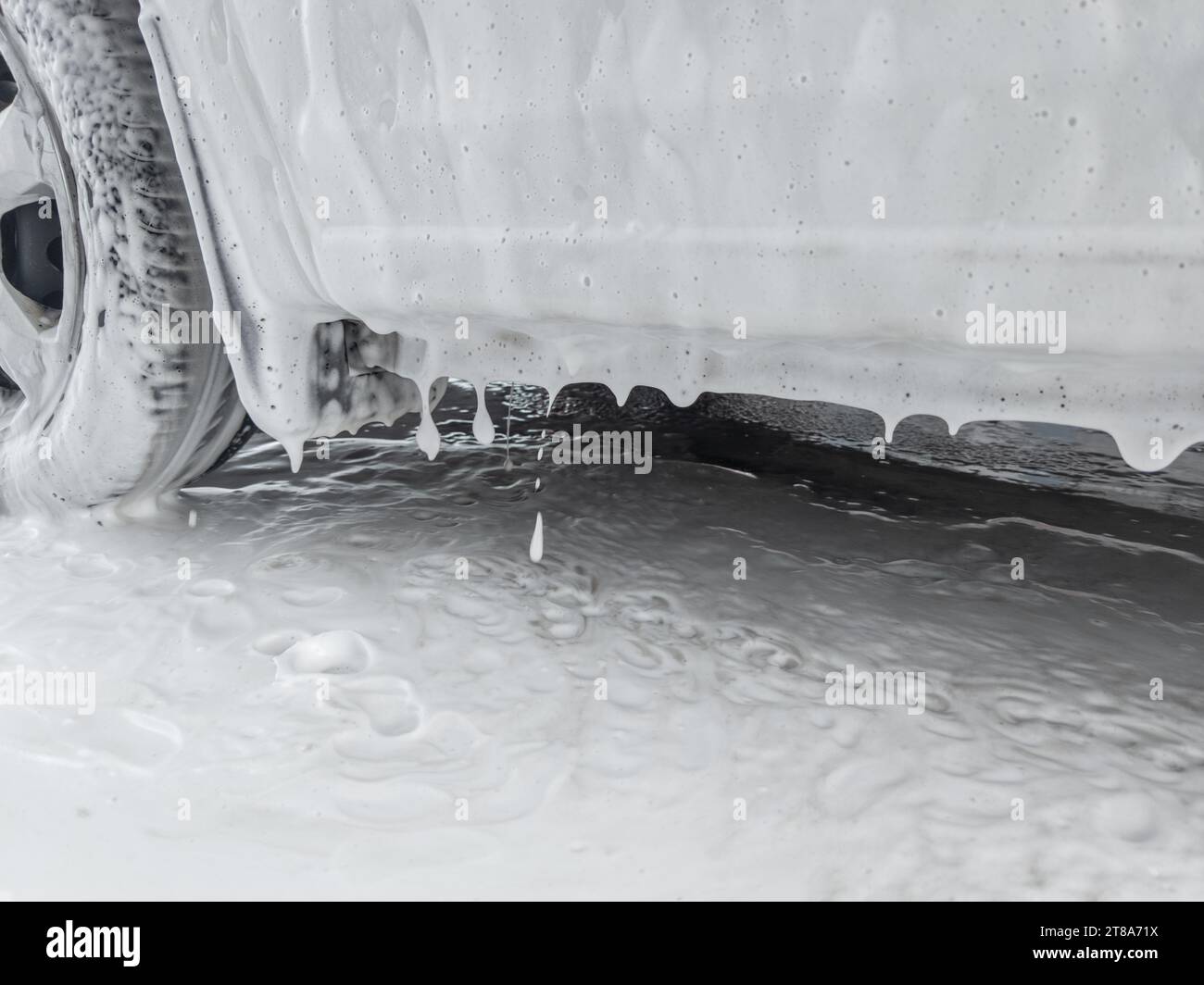 soap sud dripping from side of white car during car wash Stock Photo ...