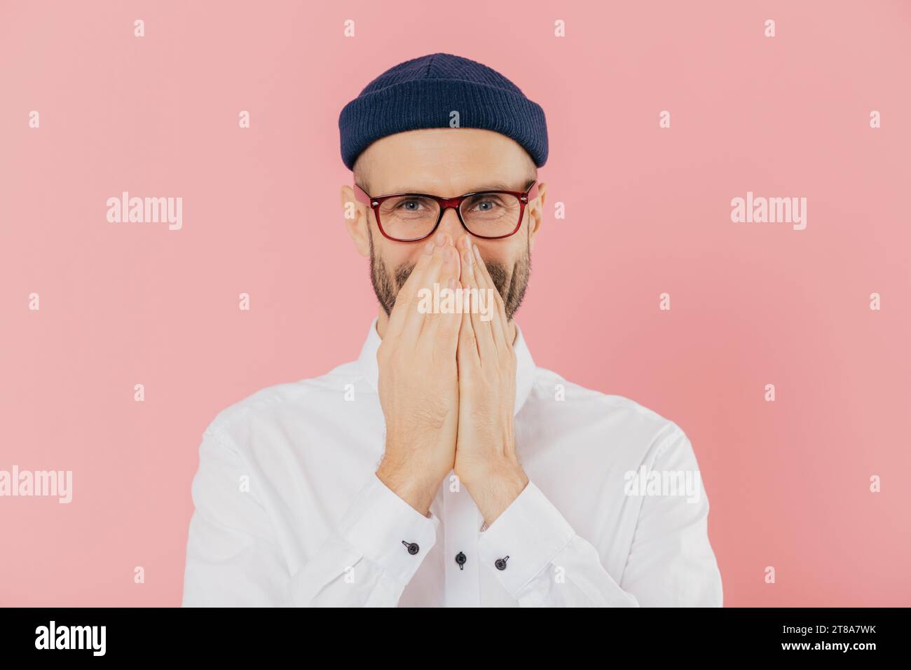 Horizontal shot of positive glad male expresses positive emotions ...