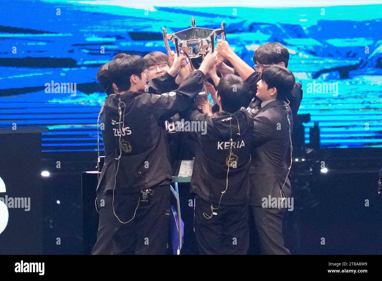 Members of team T1 celebrate with winners' trophy after winning the ...