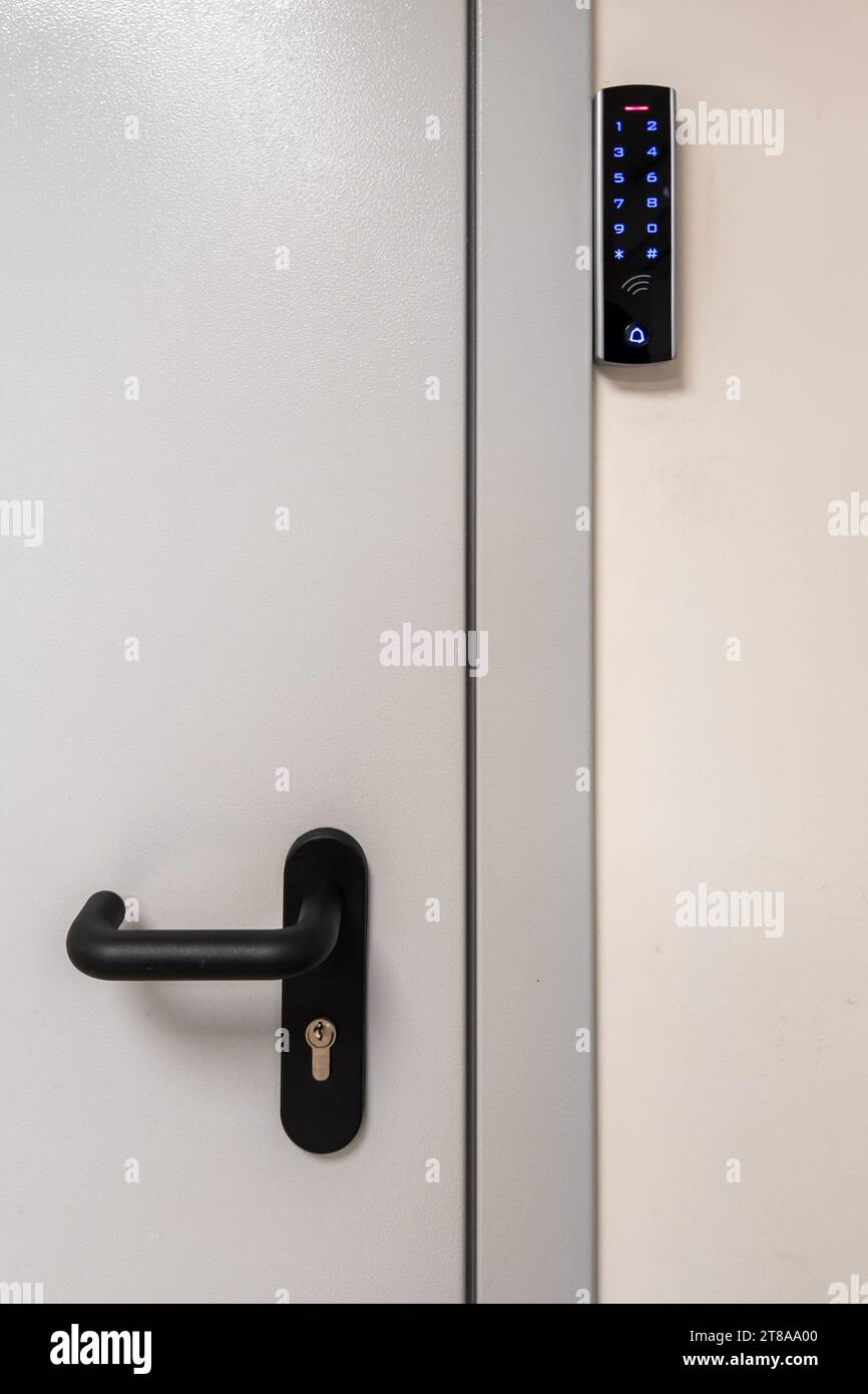 gray metal door with black handle and digital touch sensor RFID lock ...