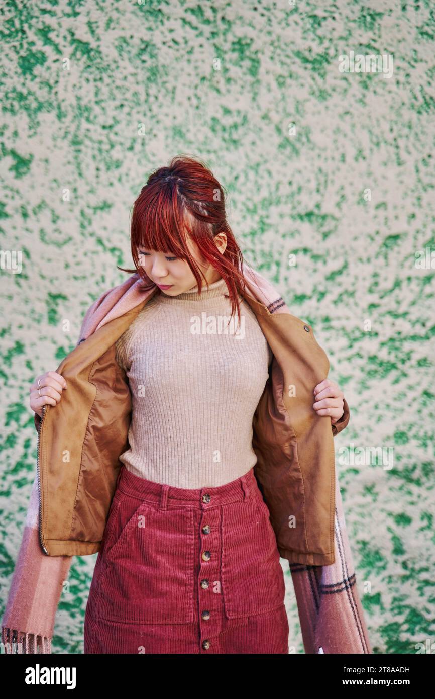 vertical portrait of a young asian woman opening her jacket Stock Photo ...