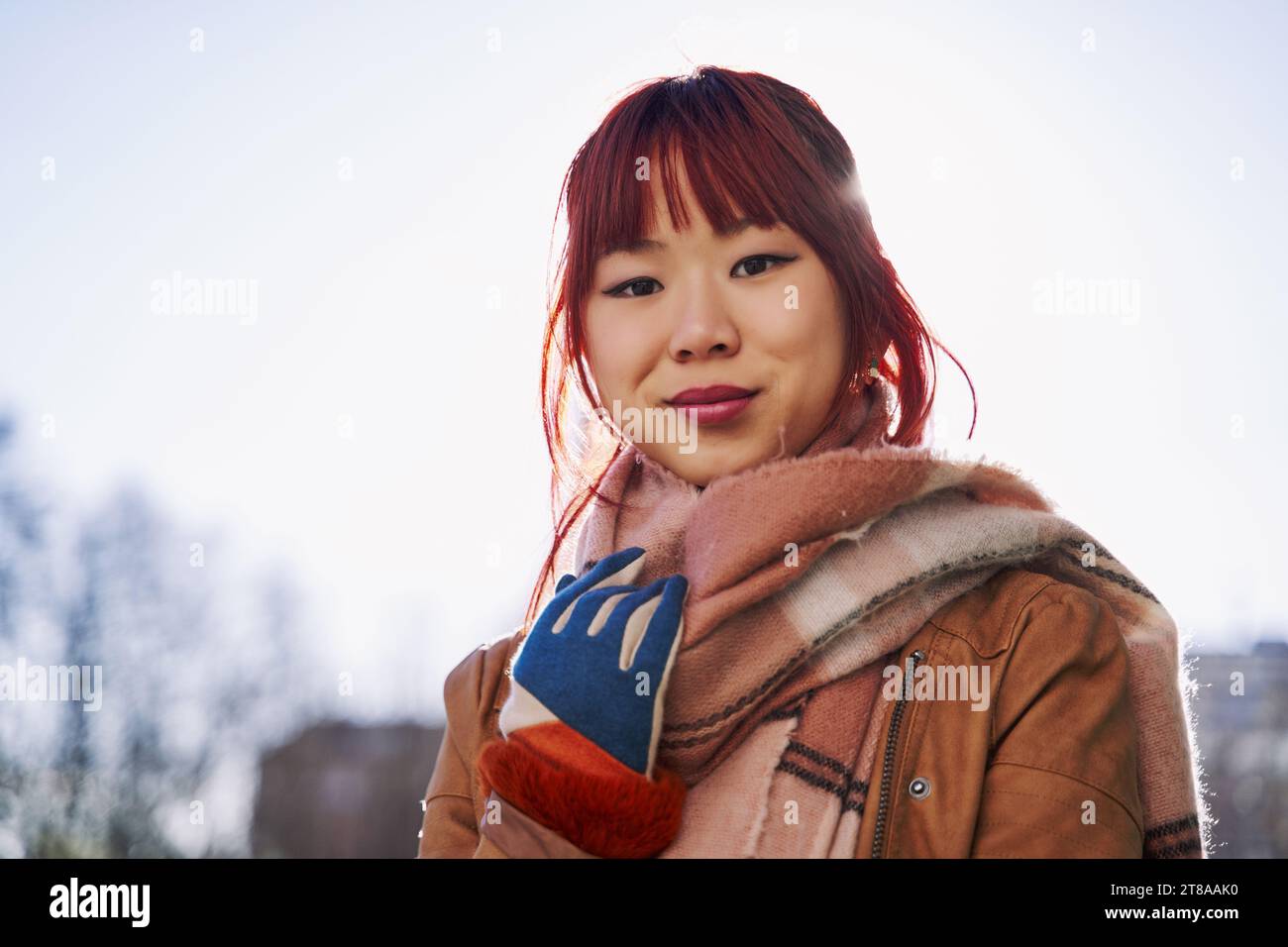 Young confident smiling Asian woman standing on street, portrait. Proud ...