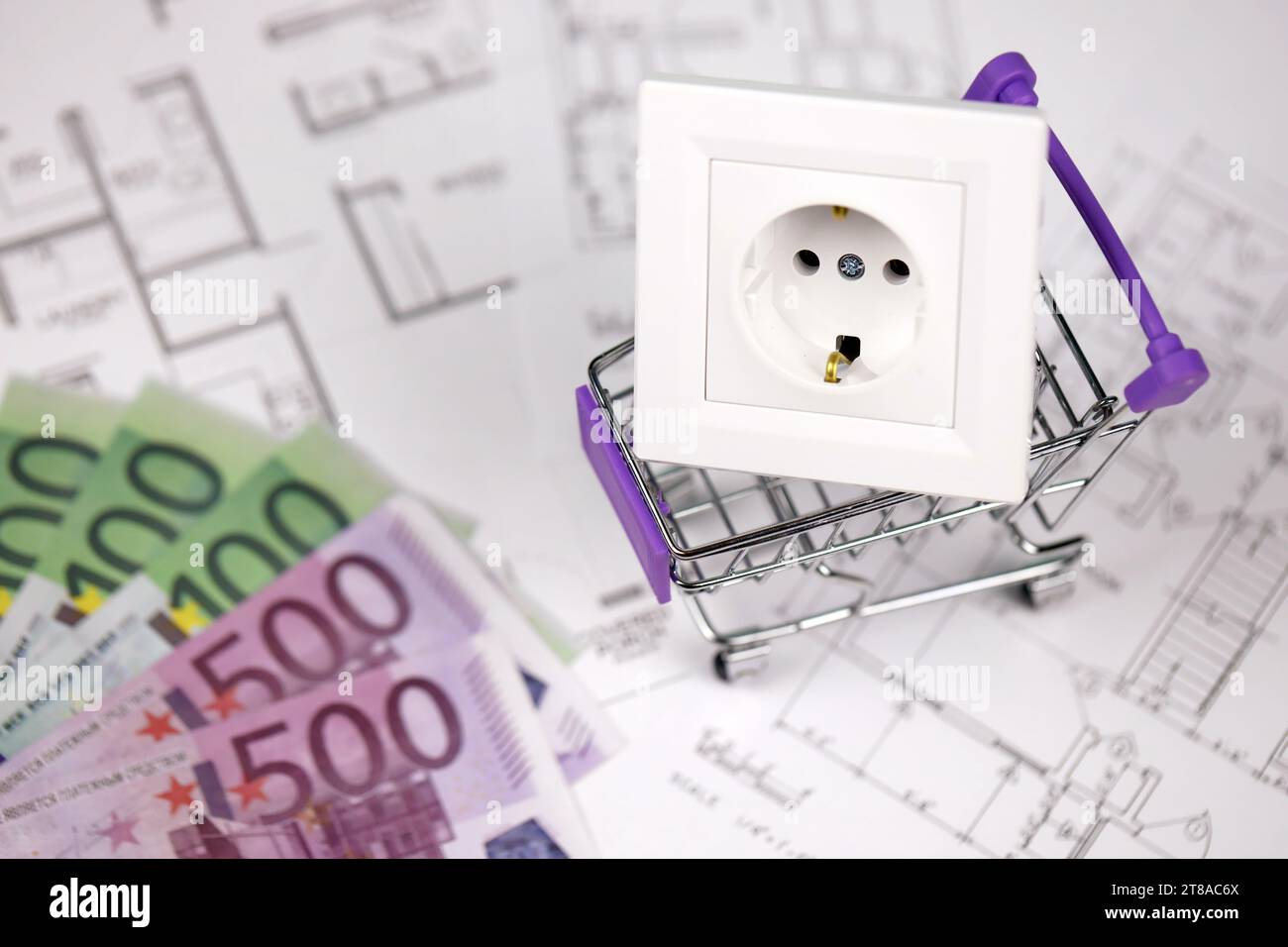 European standard EU outlet in small shopping cart on blueprints of ...