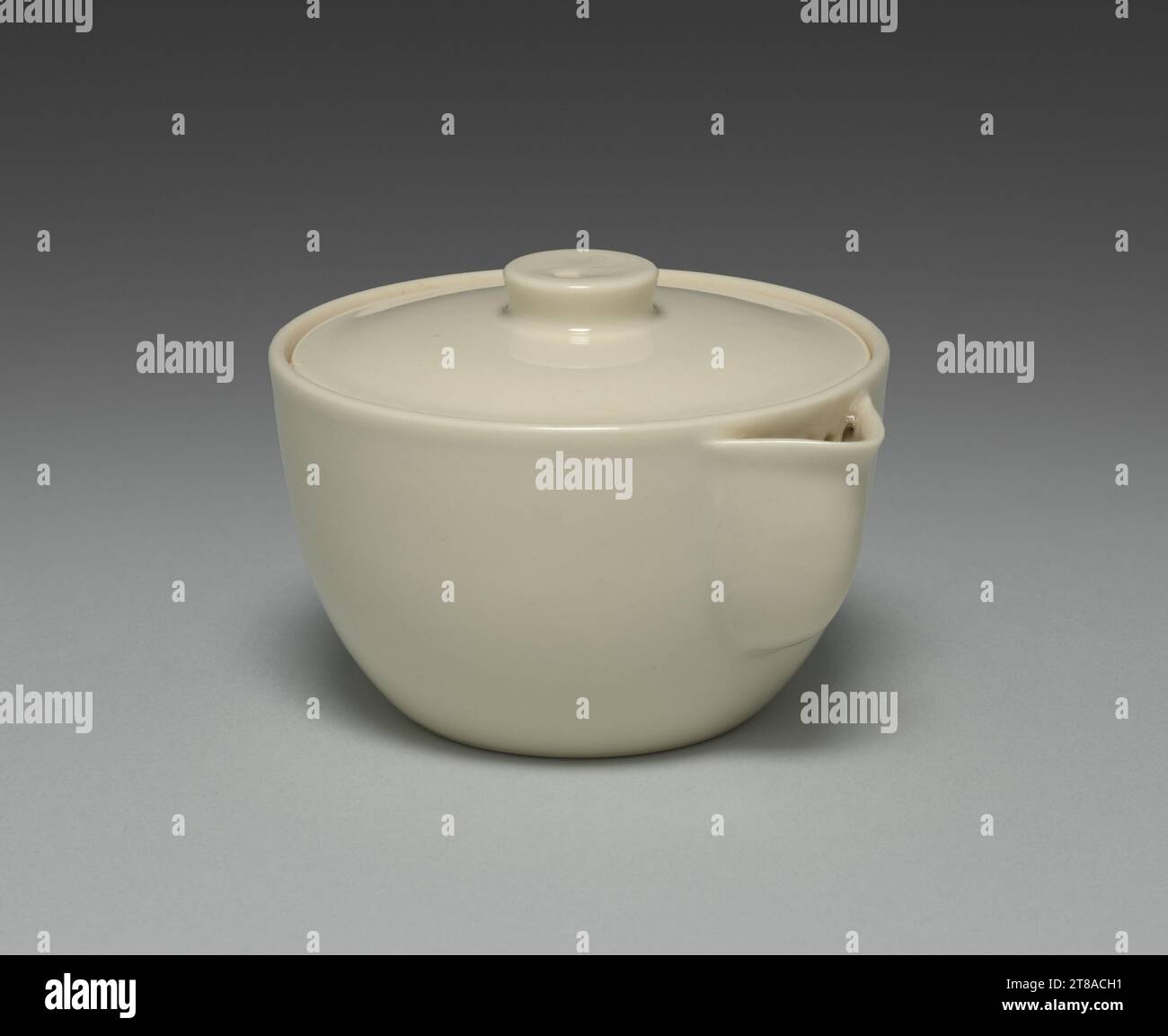 The handheld teapot is an example of a translucent creamy glaze over an ...