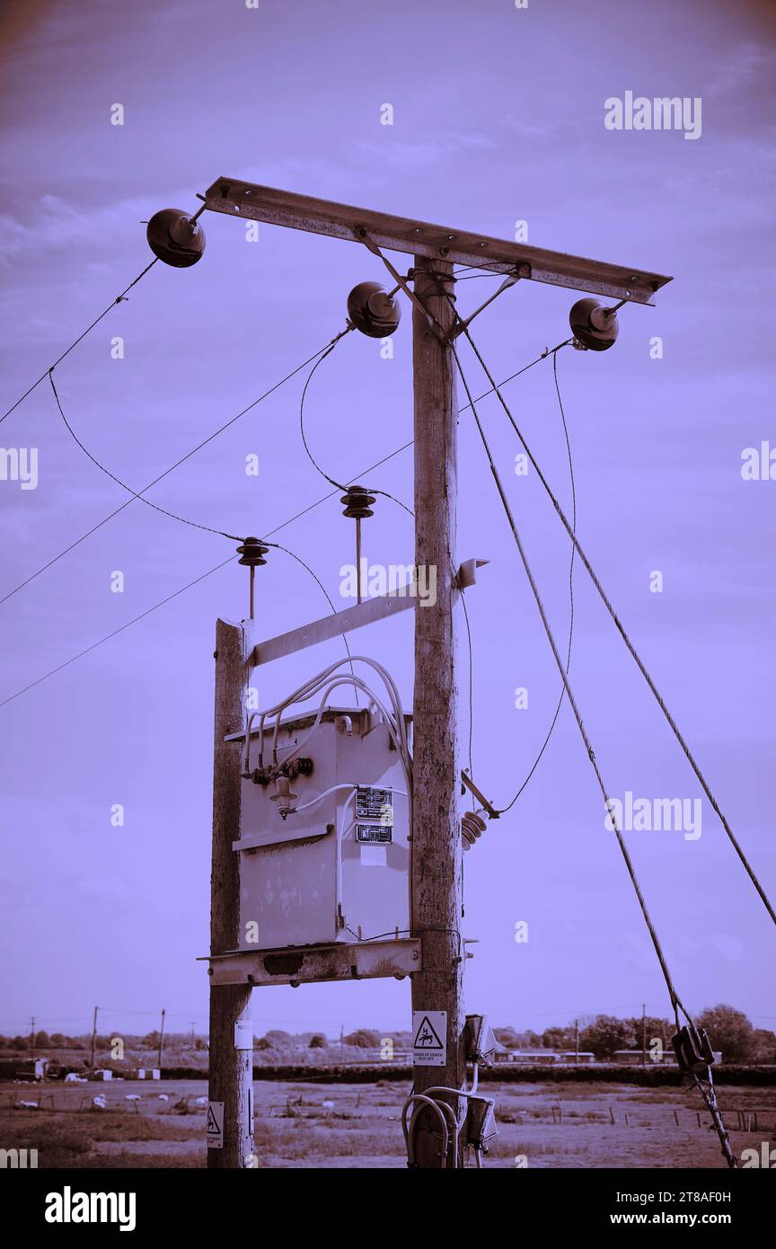 Rural electricity transformer and power lines against sky Stock Photo ...