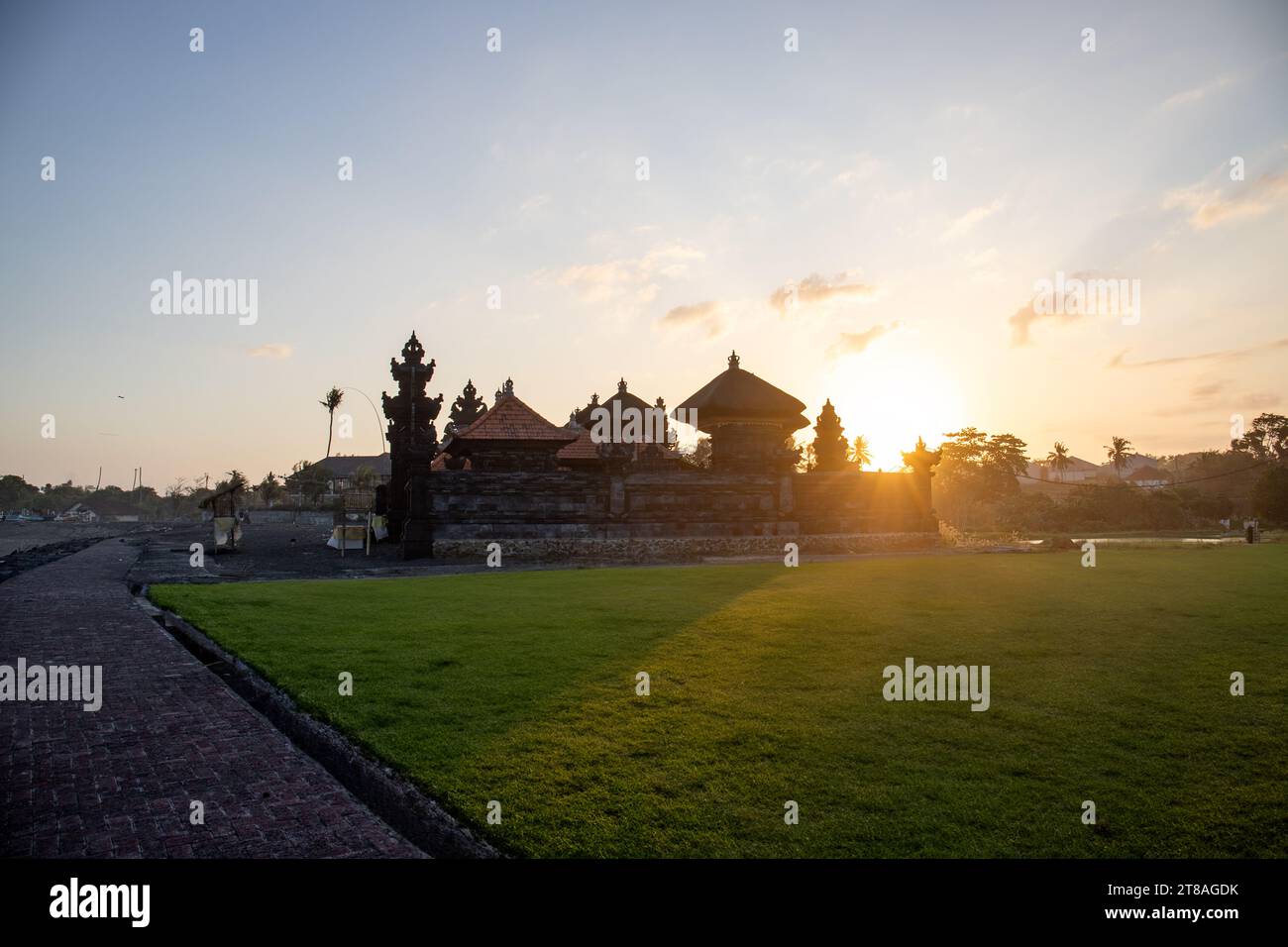 Hindu temple on a black sand beach directly by the sea. Evening ...