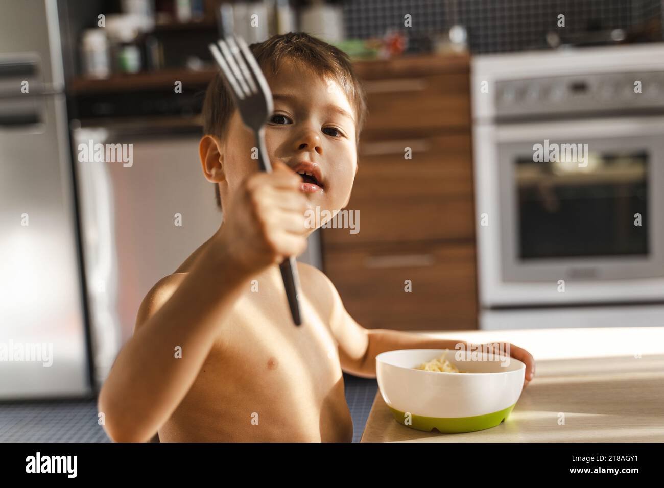 Cute toddler boy eating his favorite food - Spaghetti Stock Photo - Alamy