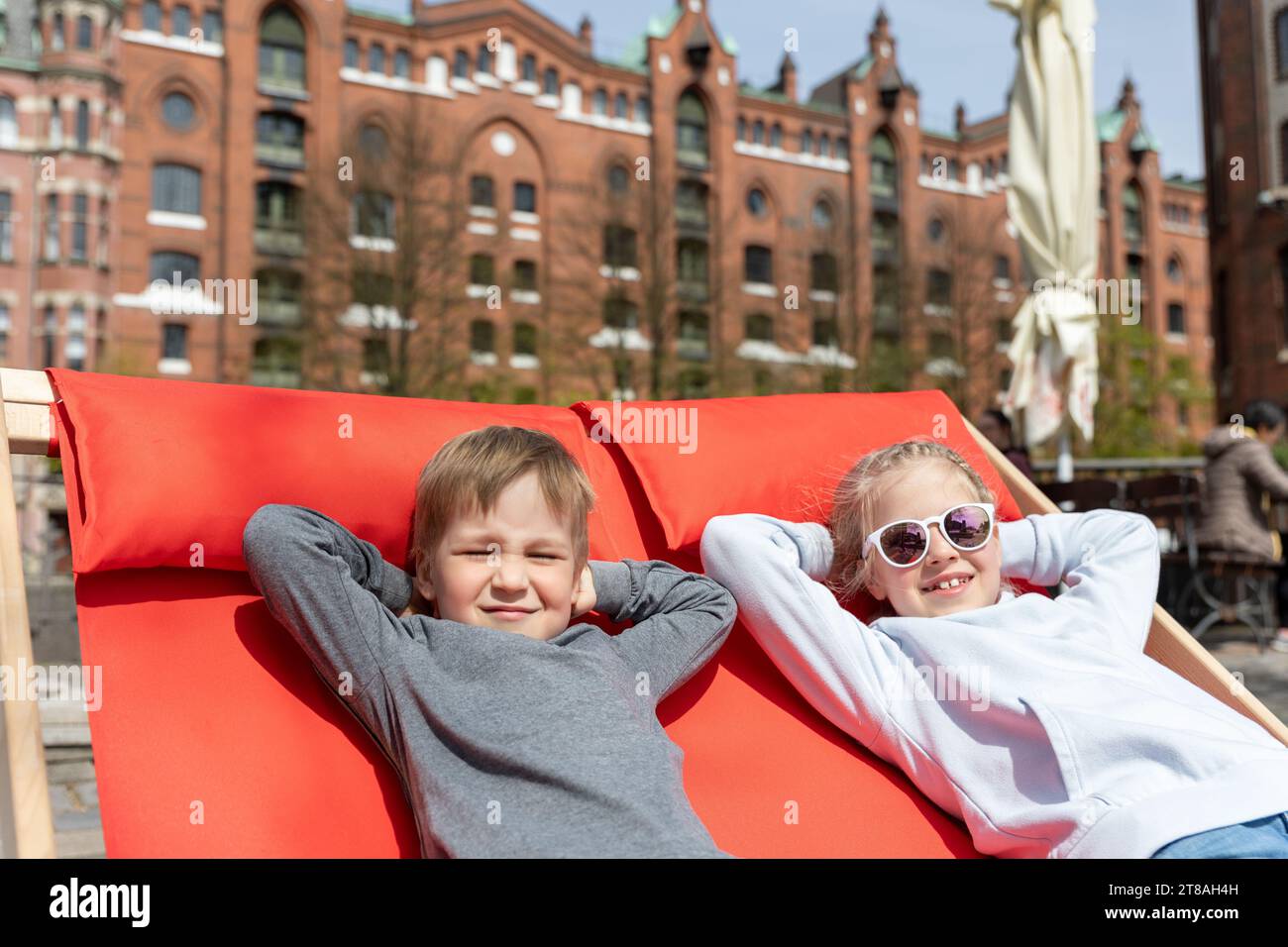 Pair of cute adorable little children enjoy having fun chilling on ...