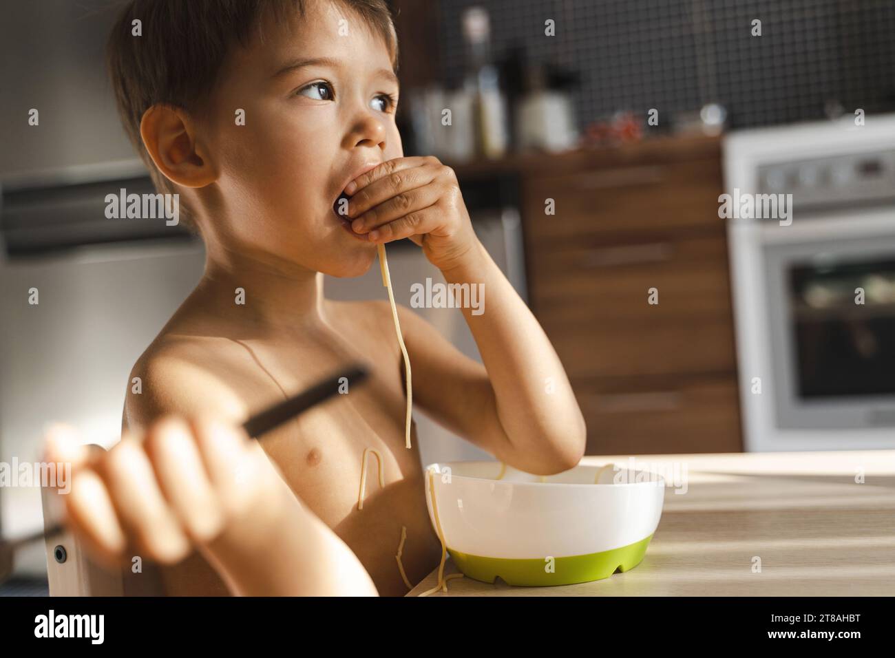 Cute toddler boy eating his favorite food - Spaghetti Stock Photo - Alamy