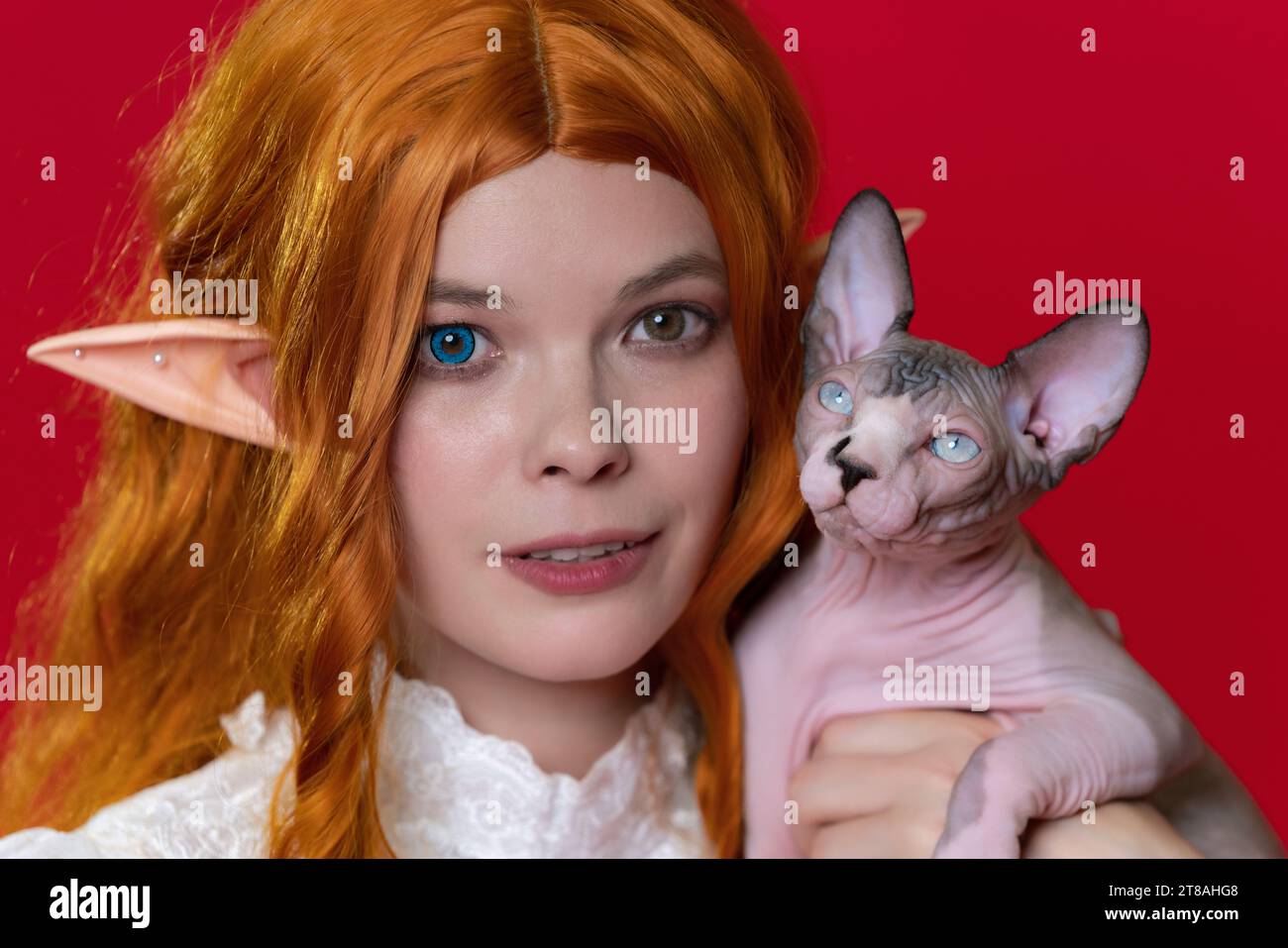 Portrait of ginger young woman cosplay elf in white dress with ...