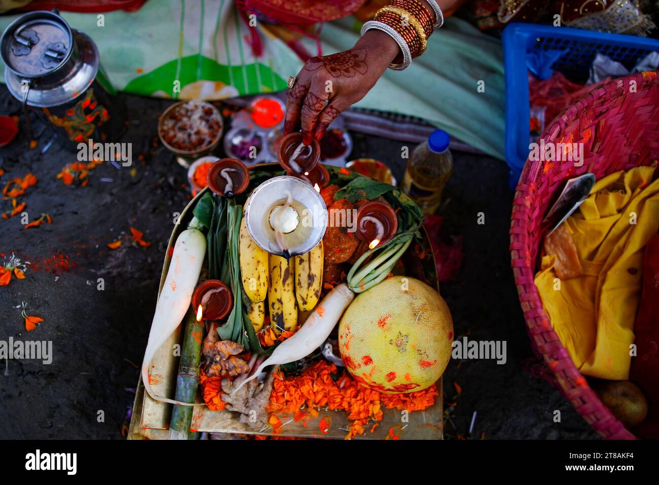 A Nepalese Hindu woman arranging offerings before prayers to the ...