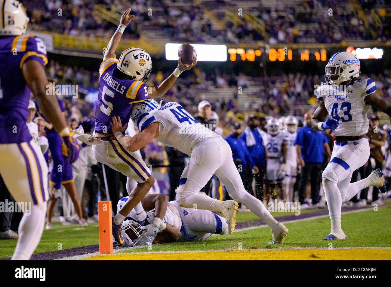 LSU quarterback Jayden Daniels (5) is pushed out of bounds on the one ...