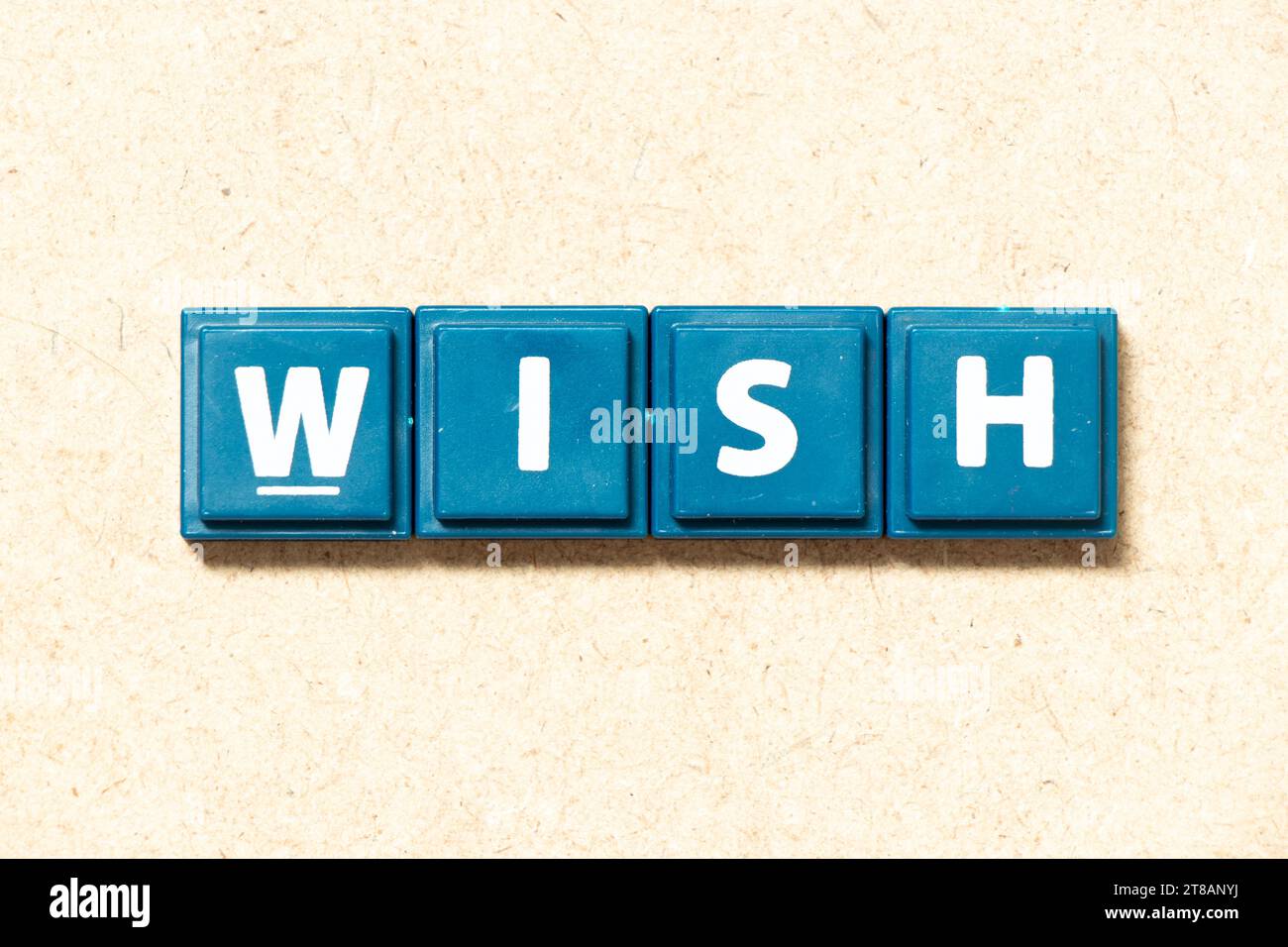 Tile alphabet letter in word wish on wood background Stock Photo - Alamy