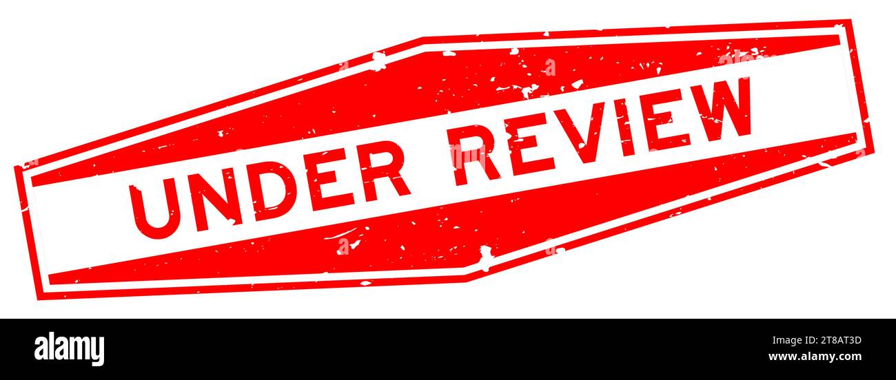 Grunge red under review word hexagon rubber seal stamp on white ...