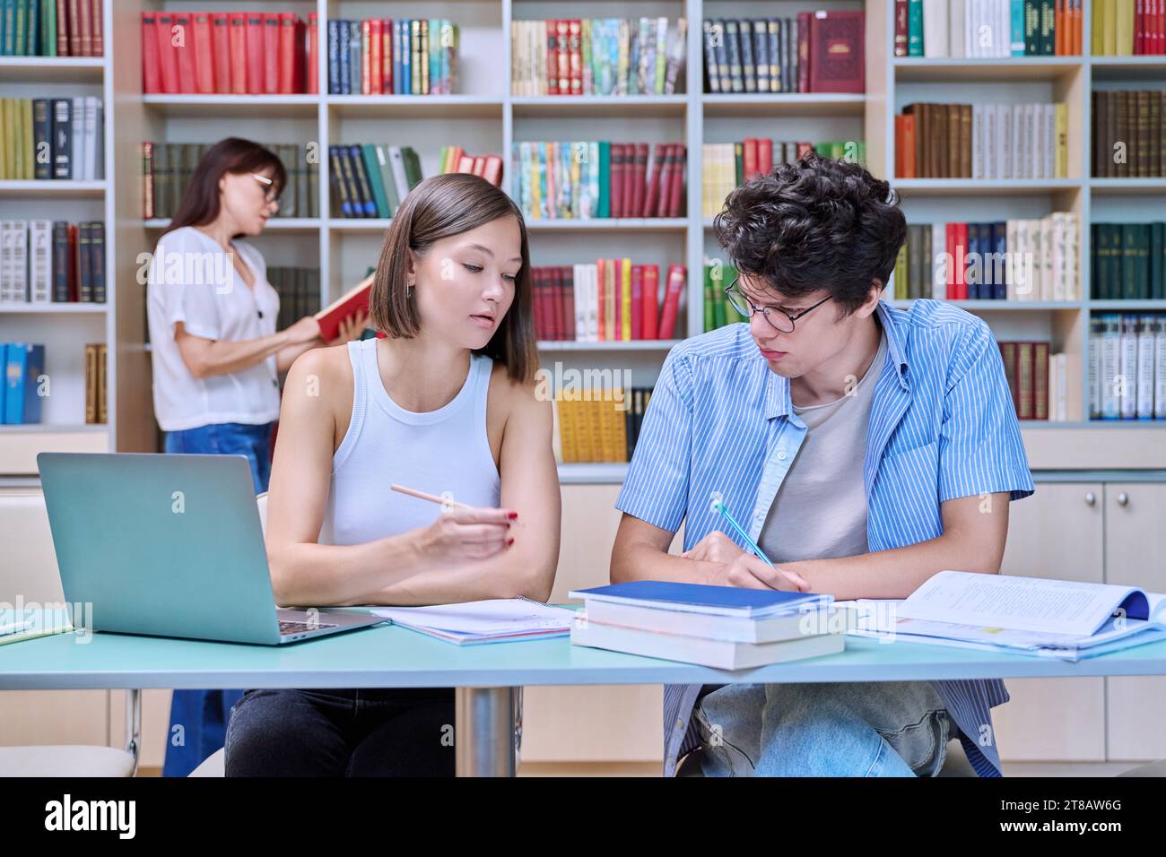 College students guy and girl study in library Stock Photo - Alamy