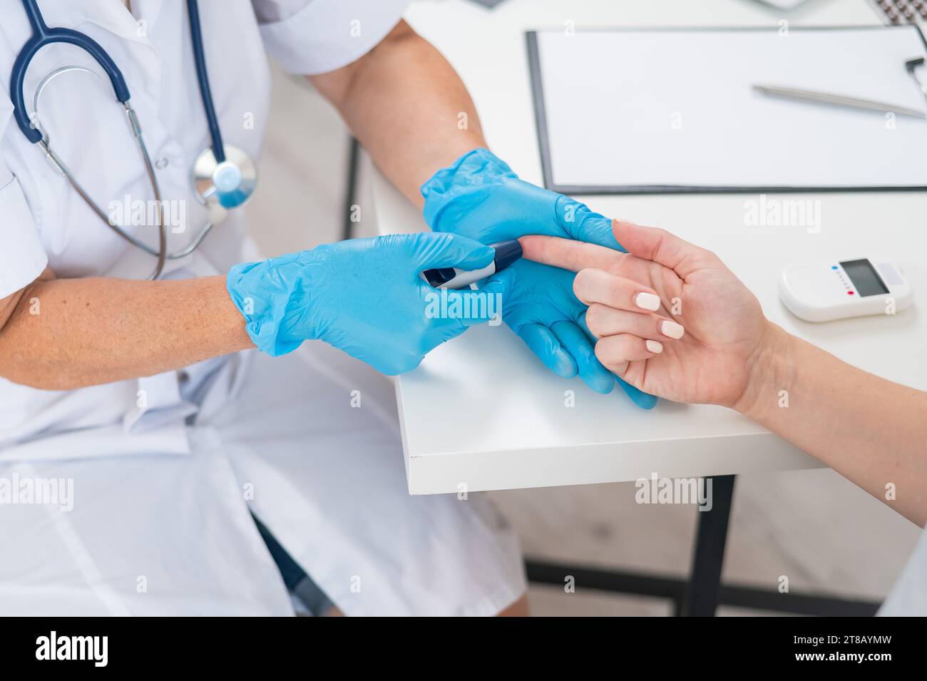 Doctor measuring patient's blood sugar level using glucometer Stock ...