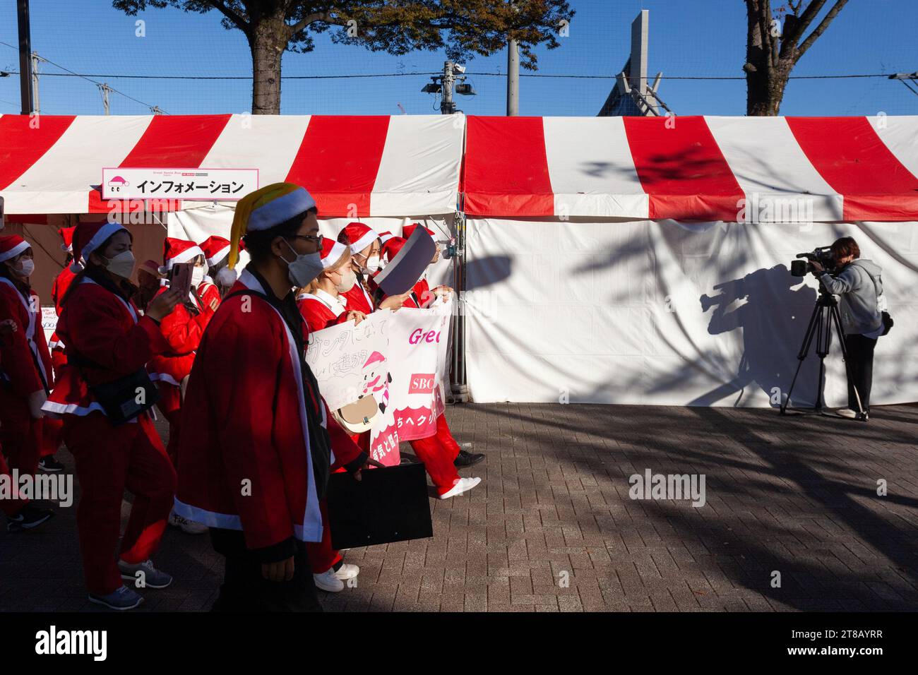 Tokyo, Japan. 19th Nov, 2023. People wearing Santa Claus costumes cross ...