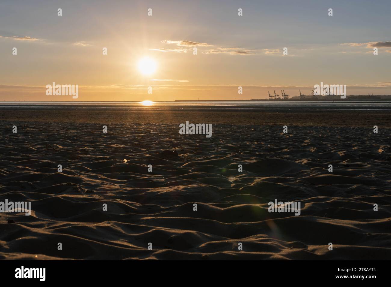 beautiful sunset on the shore of the sea the sky is golden in color due ...