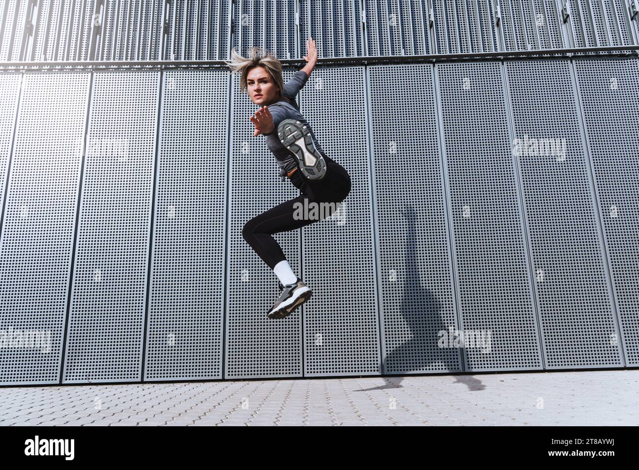 Woman performing jumping exercise on hi-res stock photography and ...