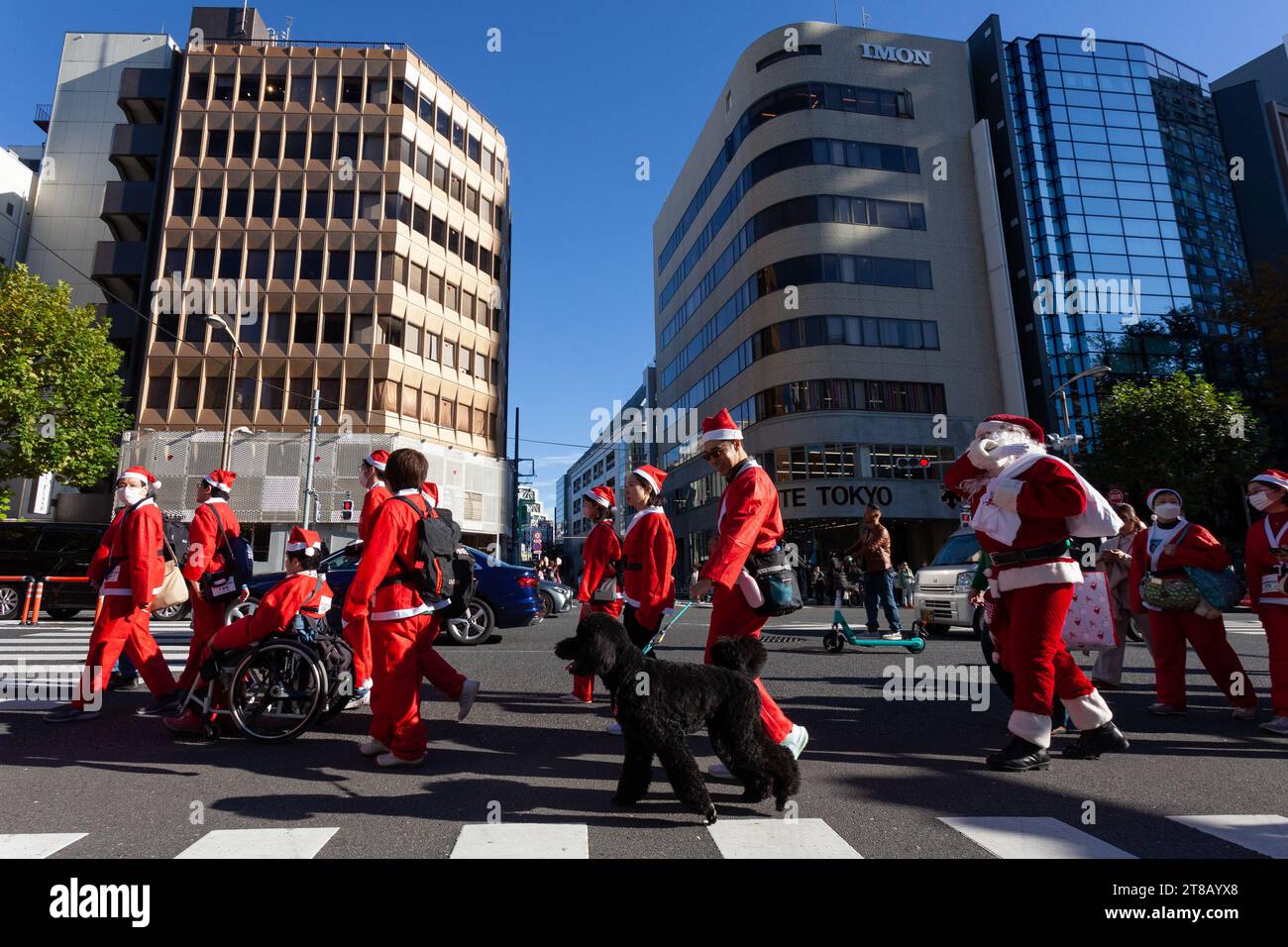 Tokyo, Japan. 19th Nov, 2023. People wearing Santa Claus costumes take ...